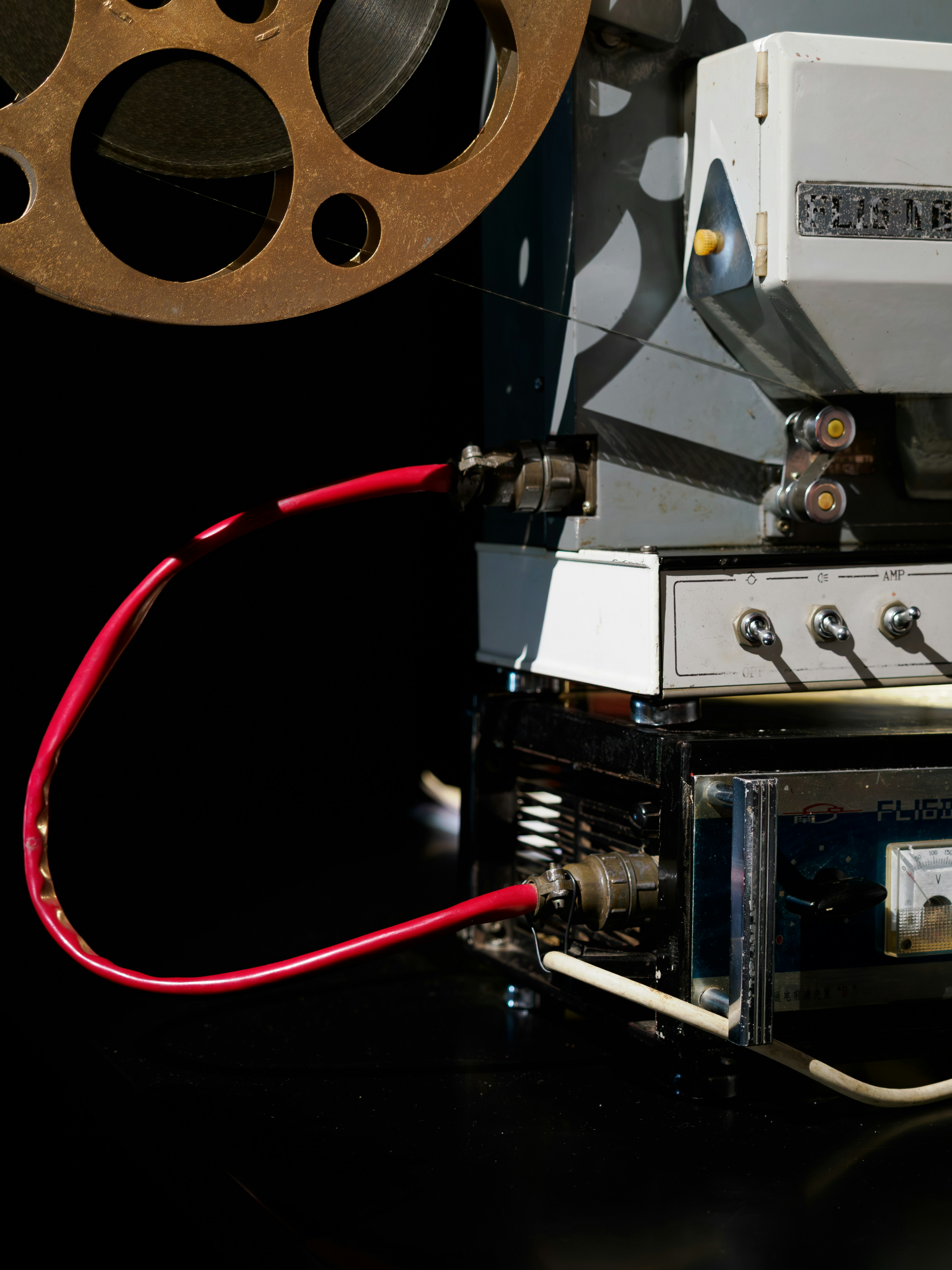 Red Cable and Vintage Mechanisms: A Moment of Industrial Light