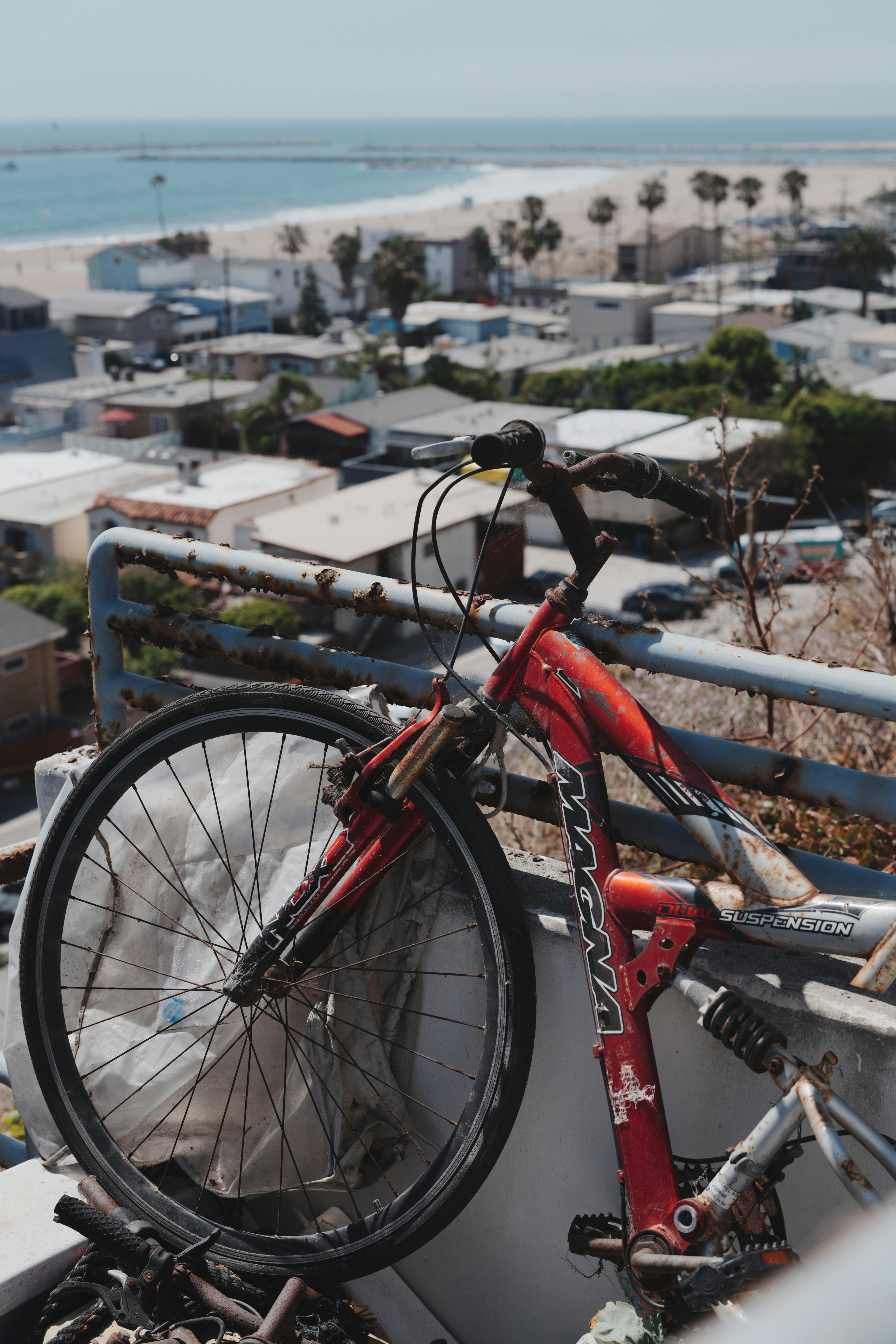 Rusted Ride Overlooking the Coast: A Worn Bicycle on a Cliffside railing