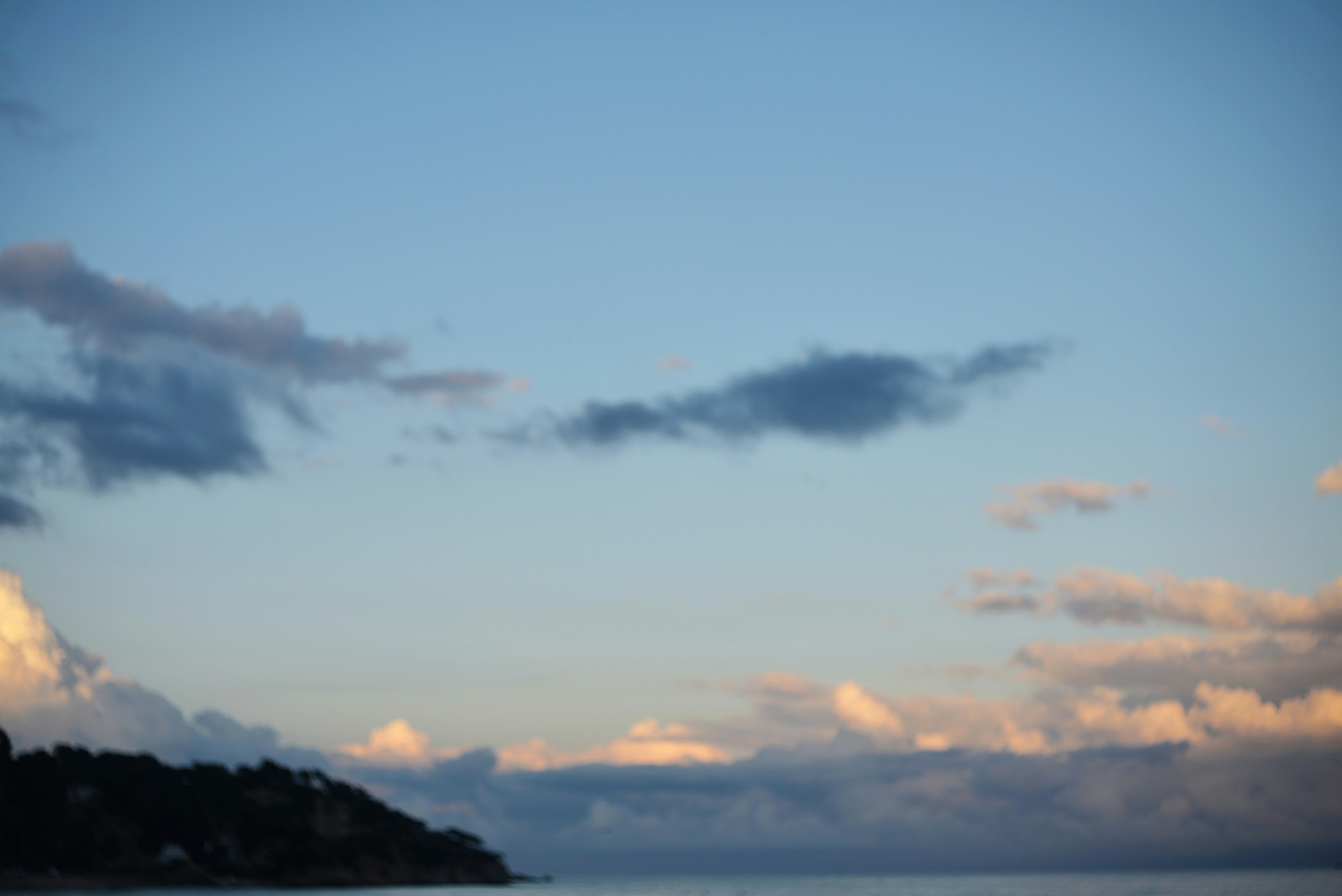 Distant Horizon Under a Soft Coral Sky