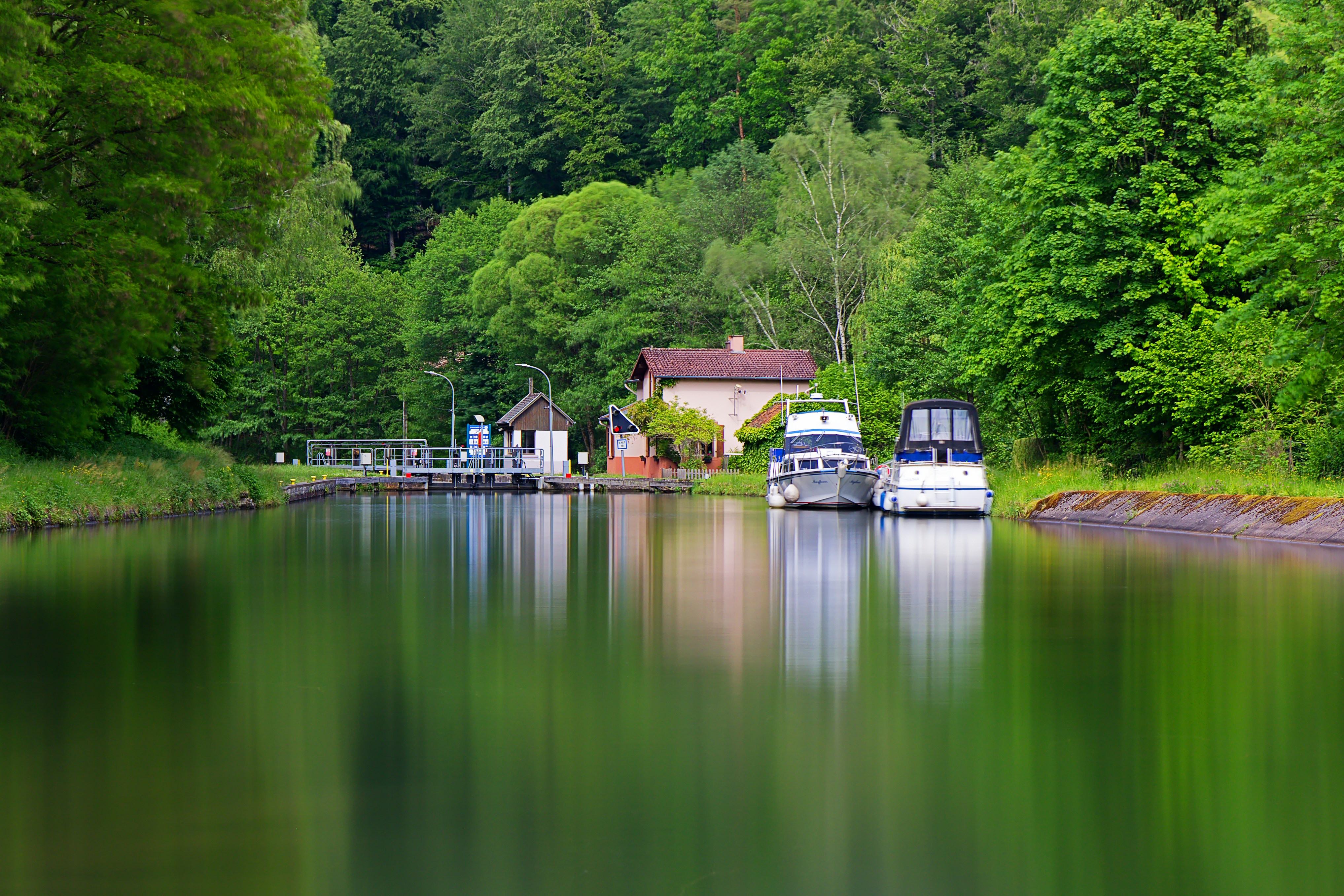 Still Waters, Quiet Docks: Boats at Rest by an Orchard Canal