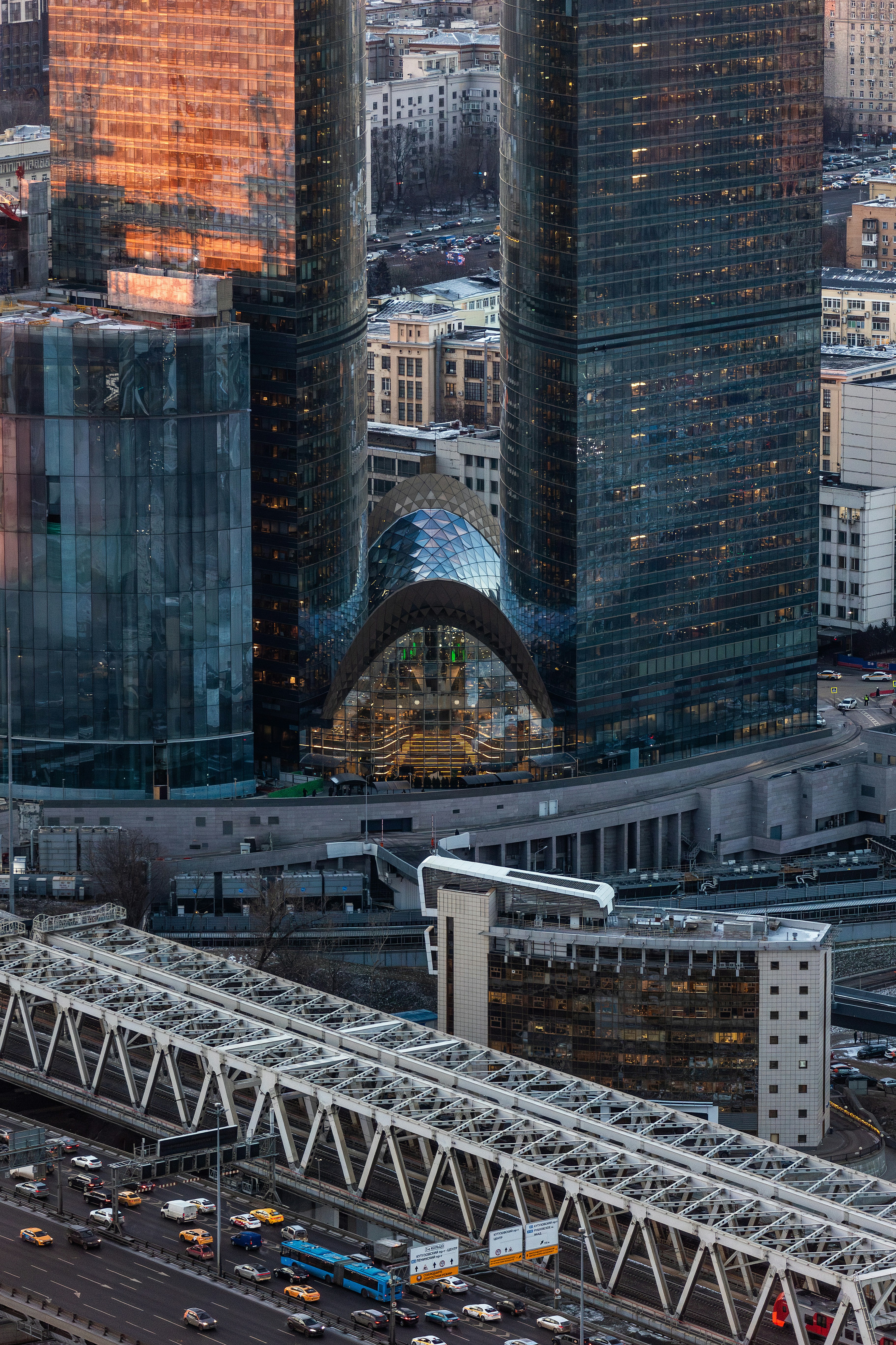 Skyscraper Gateway: Aerial View Toward the Illuminated Archway Between Glass Towers