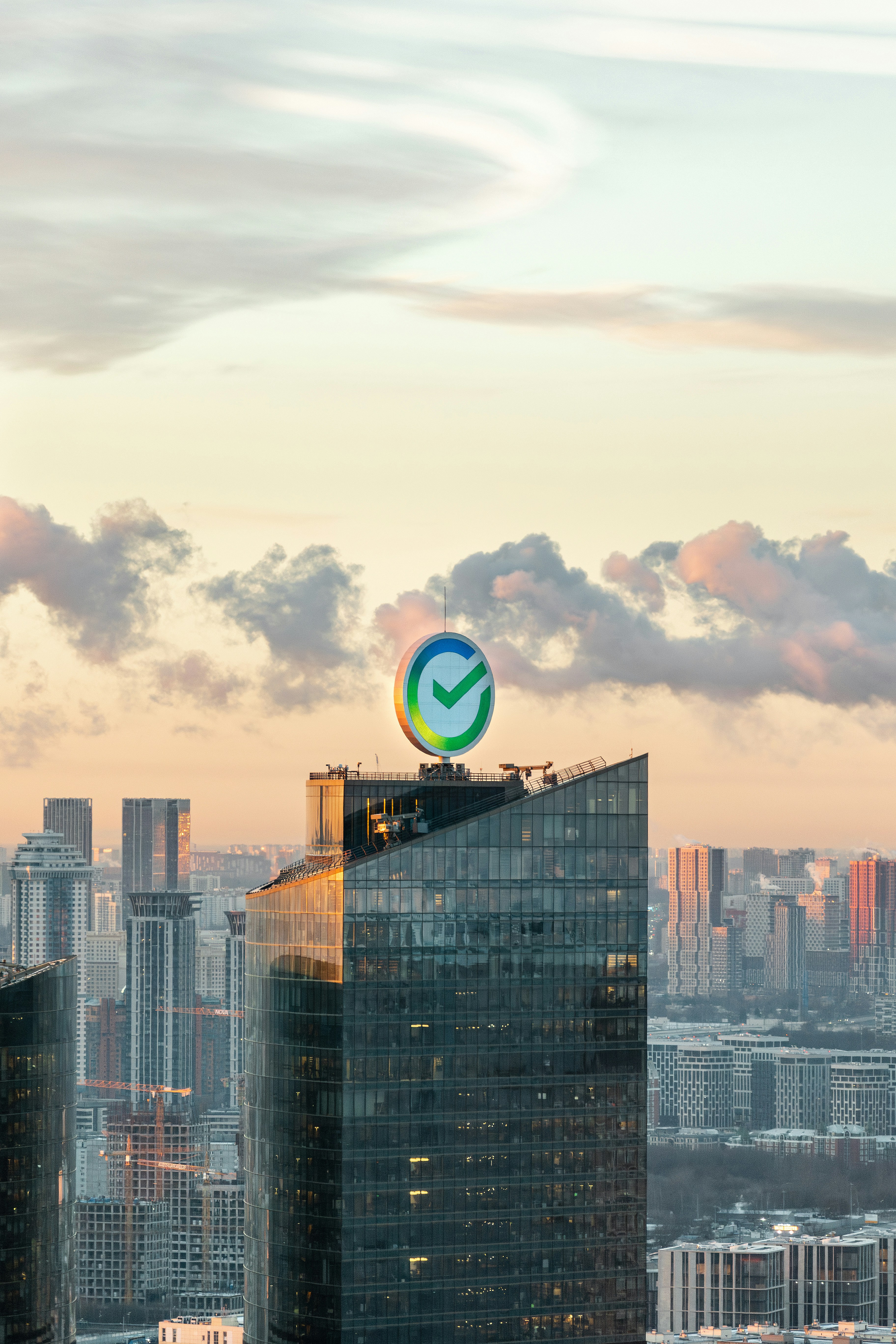 Checkmark Beacon atop a Glassy Skyline Tower at Sunset