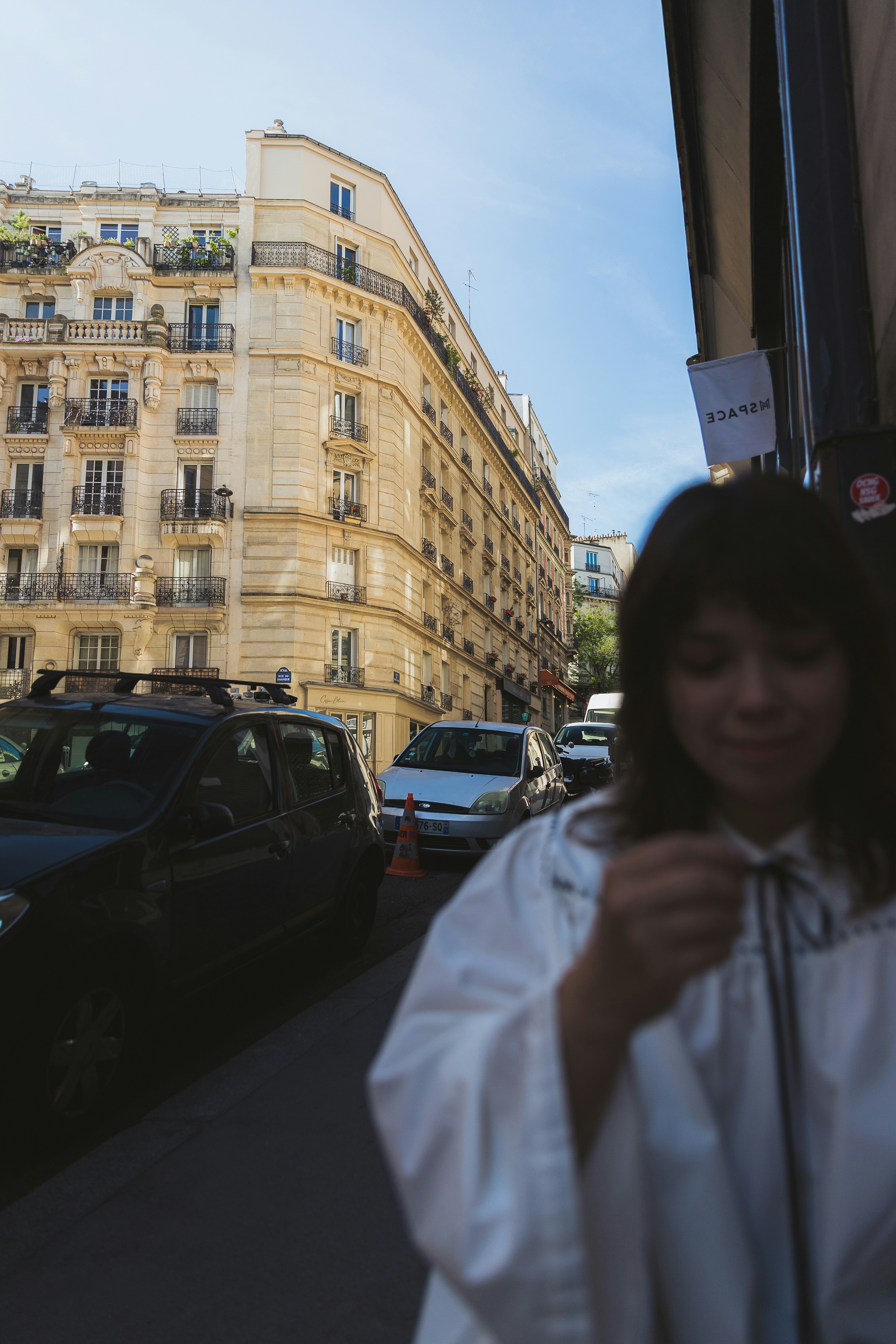 Street Portrait in Soft Focus: A Parisian Corner with a Blurred Figure