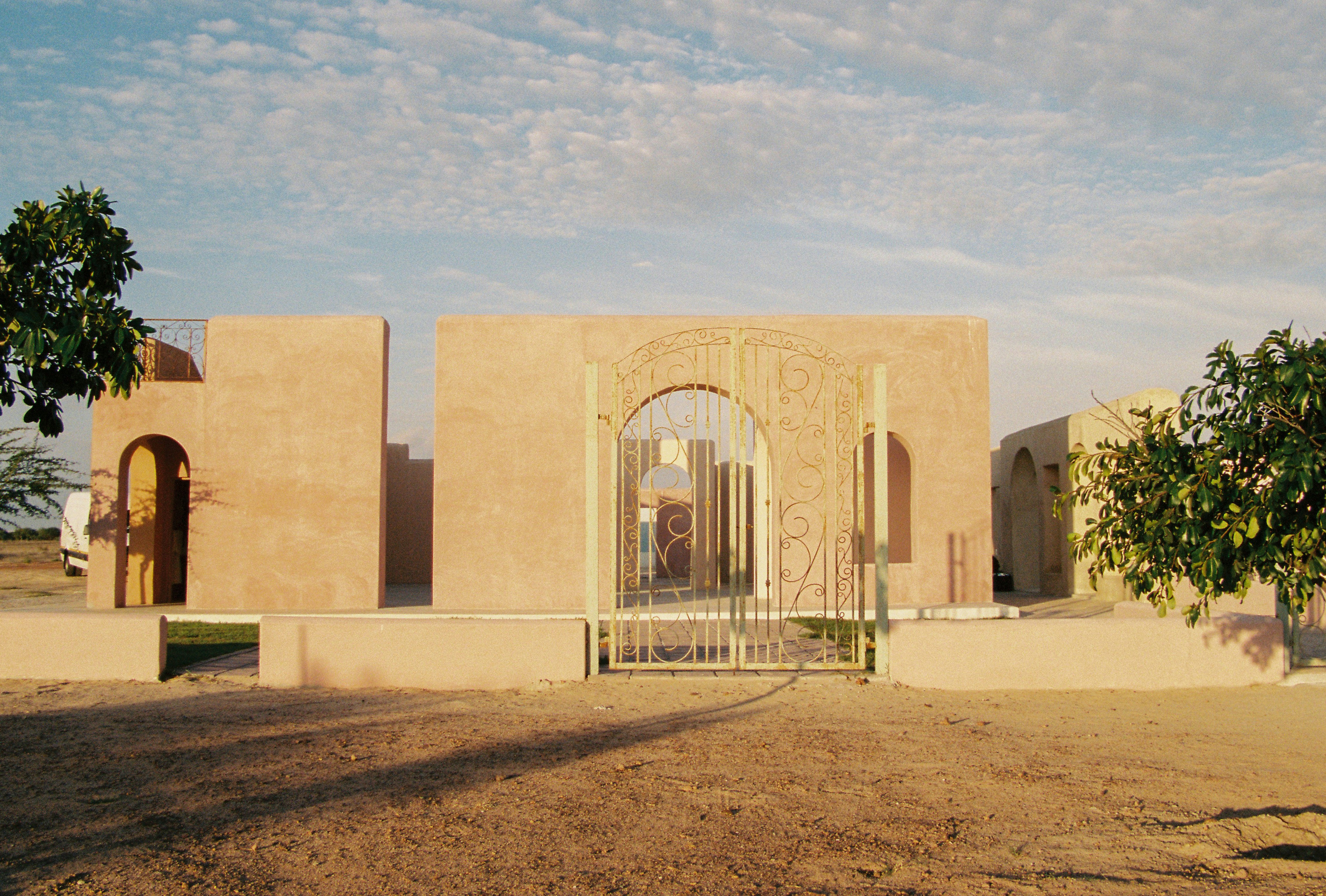 Deserted Gatehouse Centered in Warm Adobe Courtyard