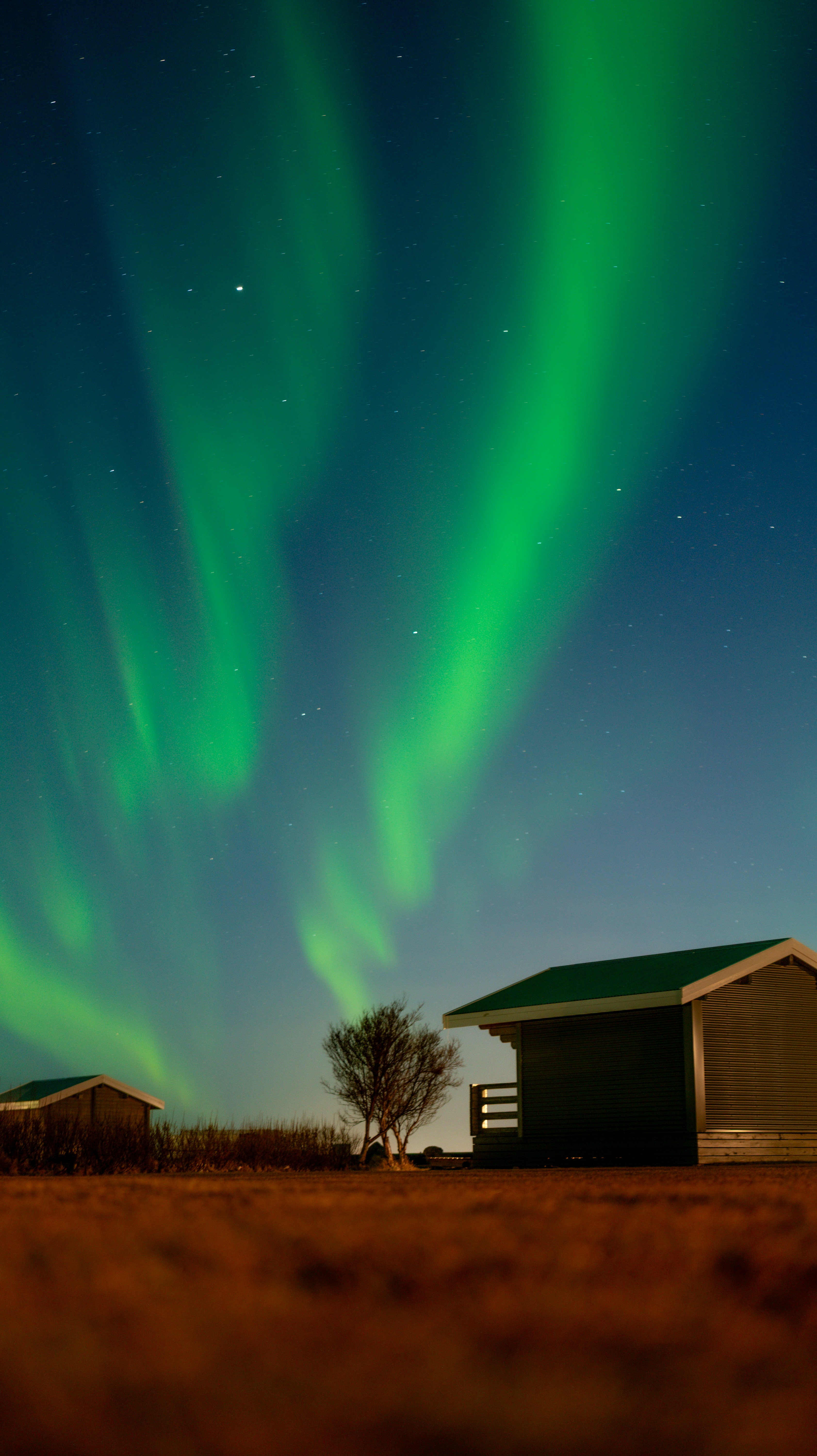Northern Threads: Aurora Veils Over Quiet Cabins