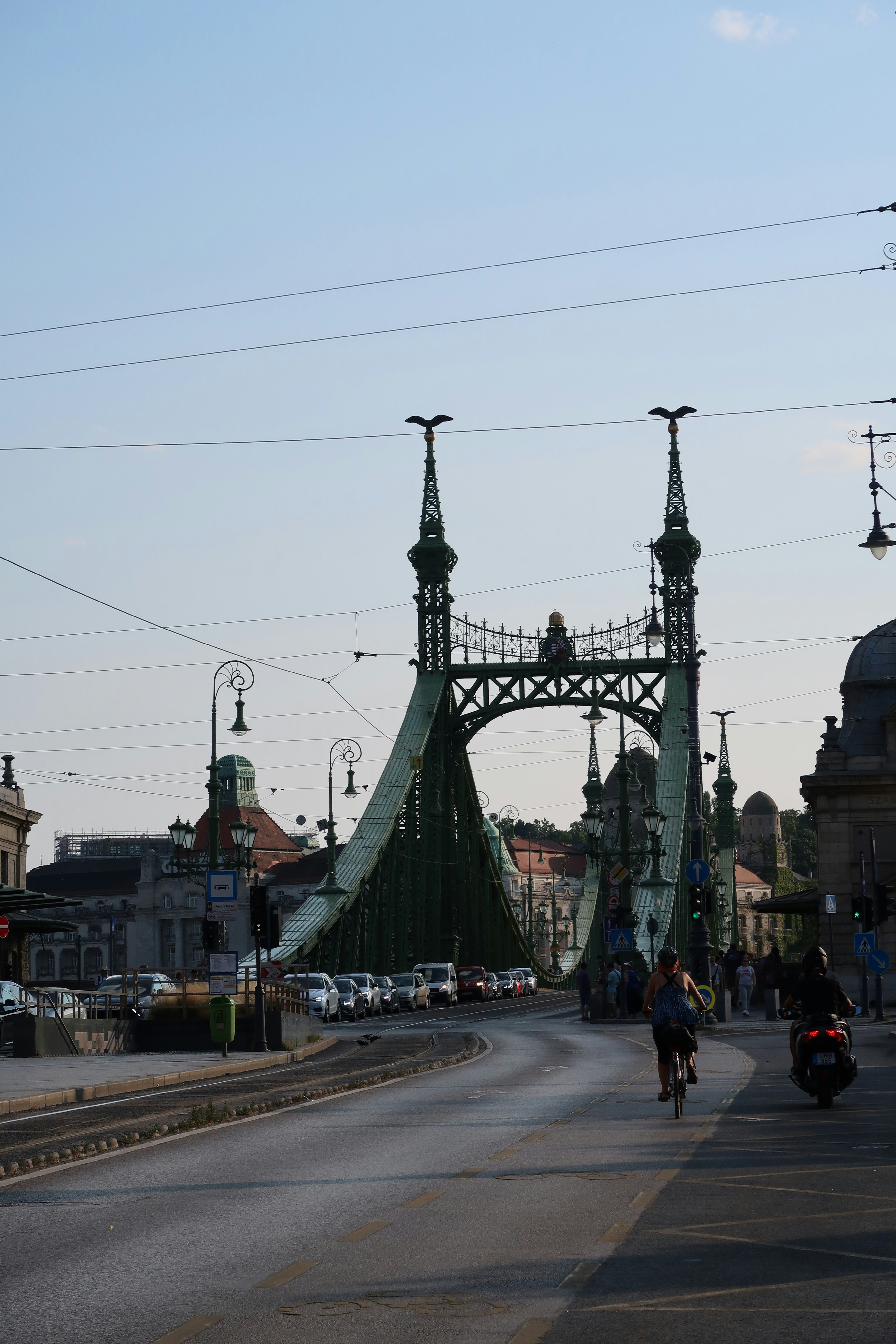 Midday Walk Across a Green-arched Bridge