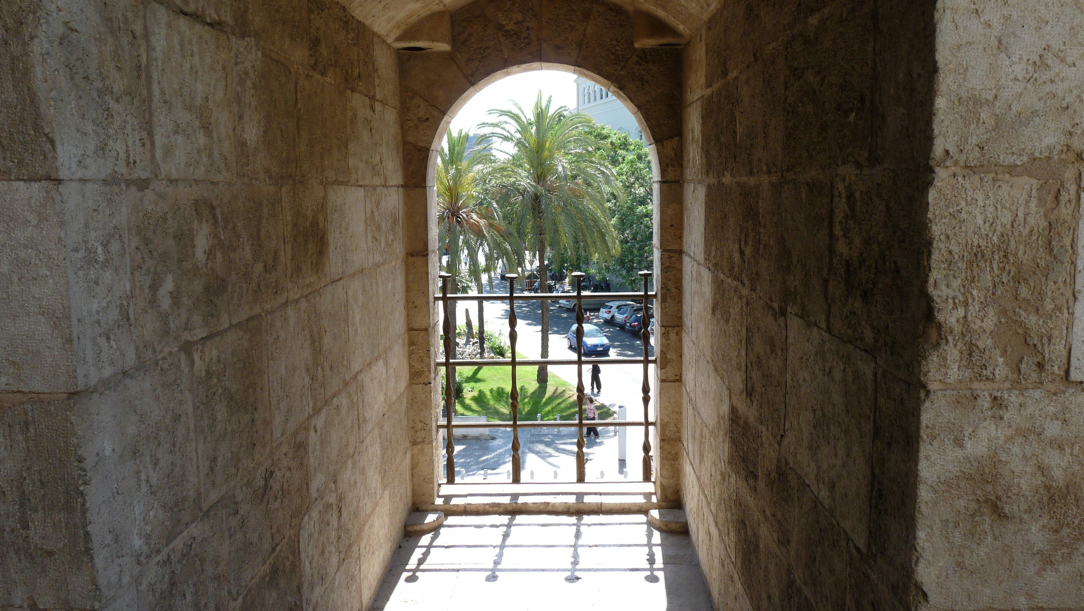 Through the Arch: a Window to the Palm-lined Courtyard