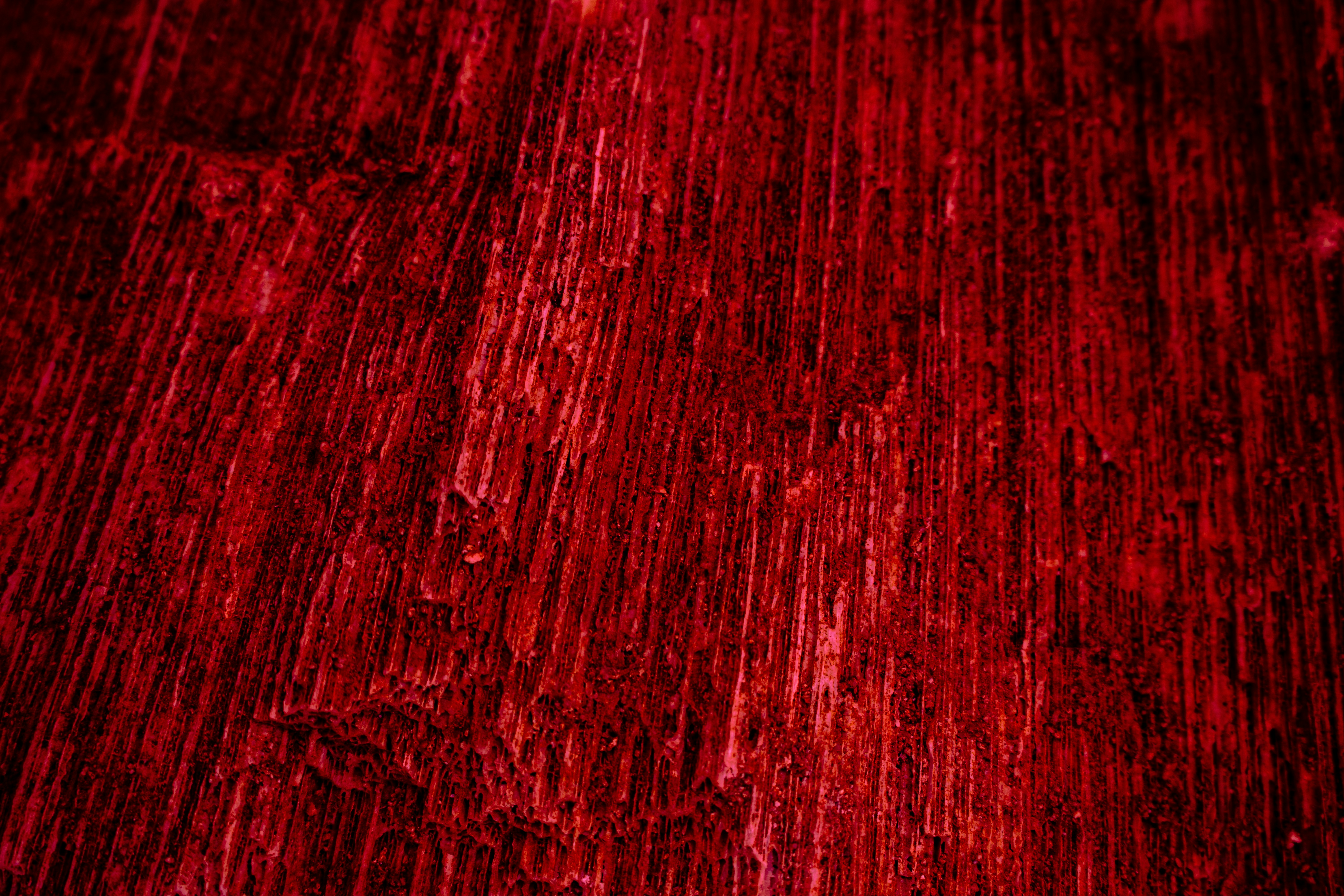 Crimson Grain: A Close-Up of Velvet-Red Timber Texture