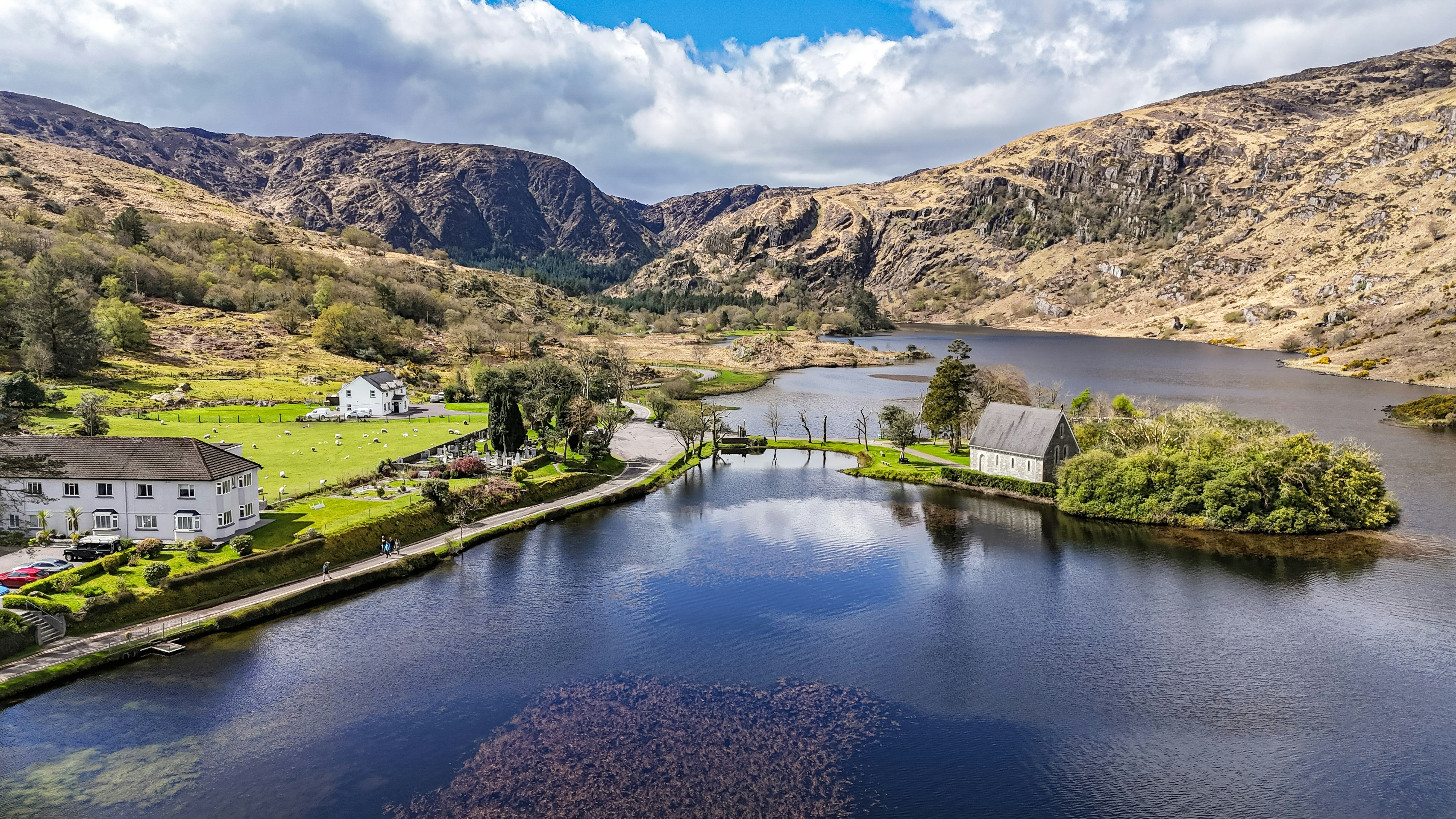 Quiet village at the edge of a winding lake under a rugged ridge