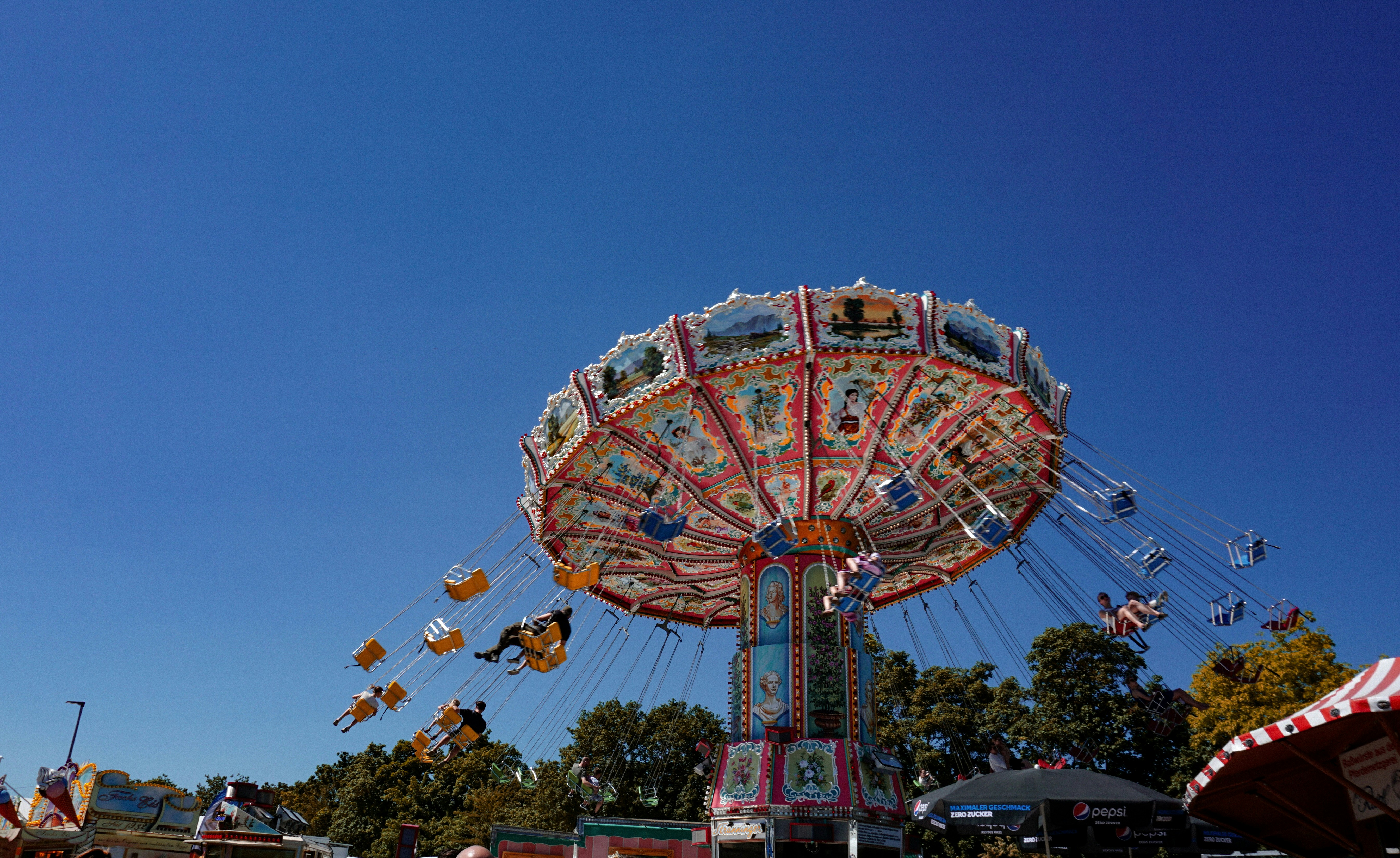 Spin of Color: A Festive Swing Under a Clear Blue Sky