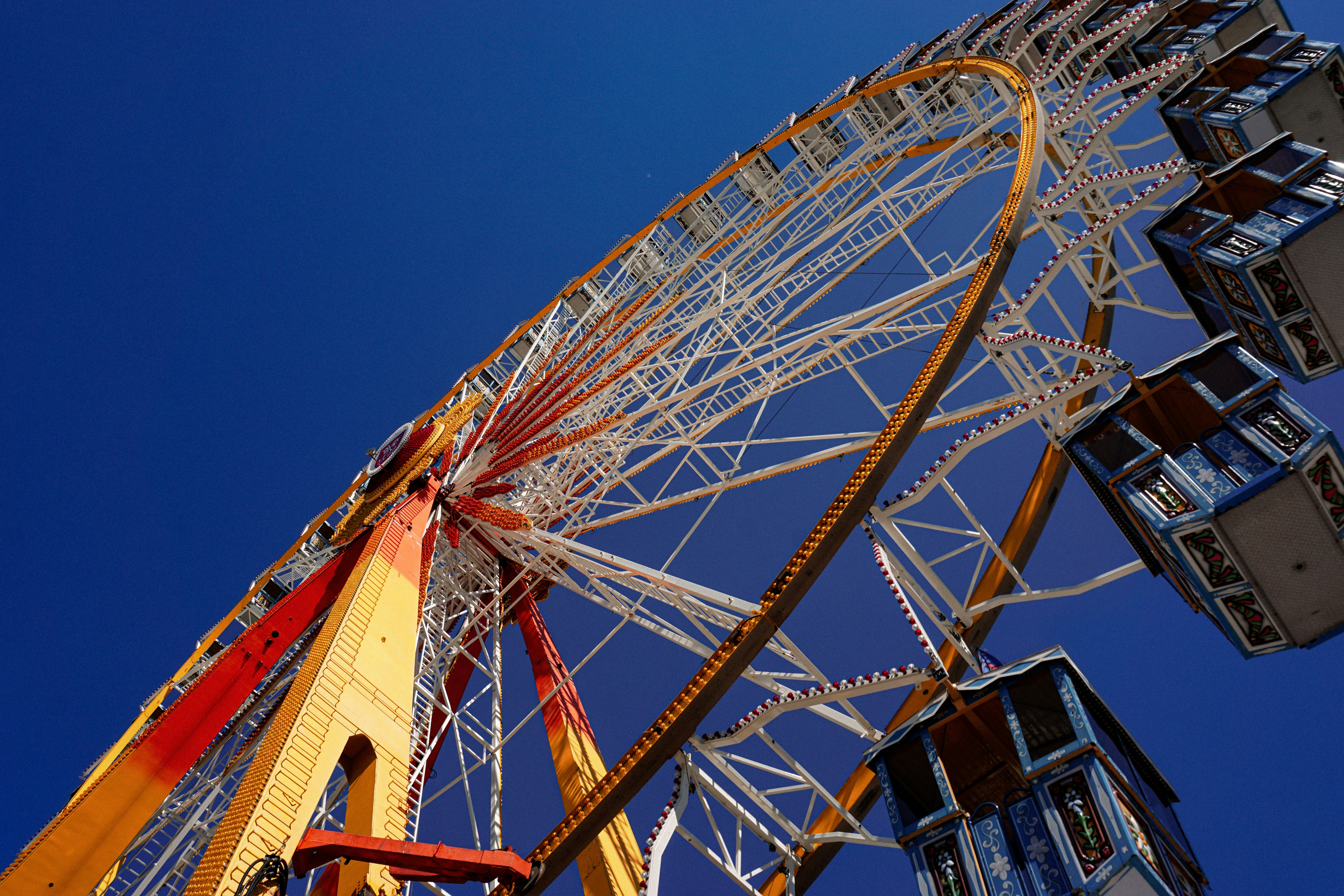 Toward the Tilted Sky: A Ferris Wheel Reaches for Blue