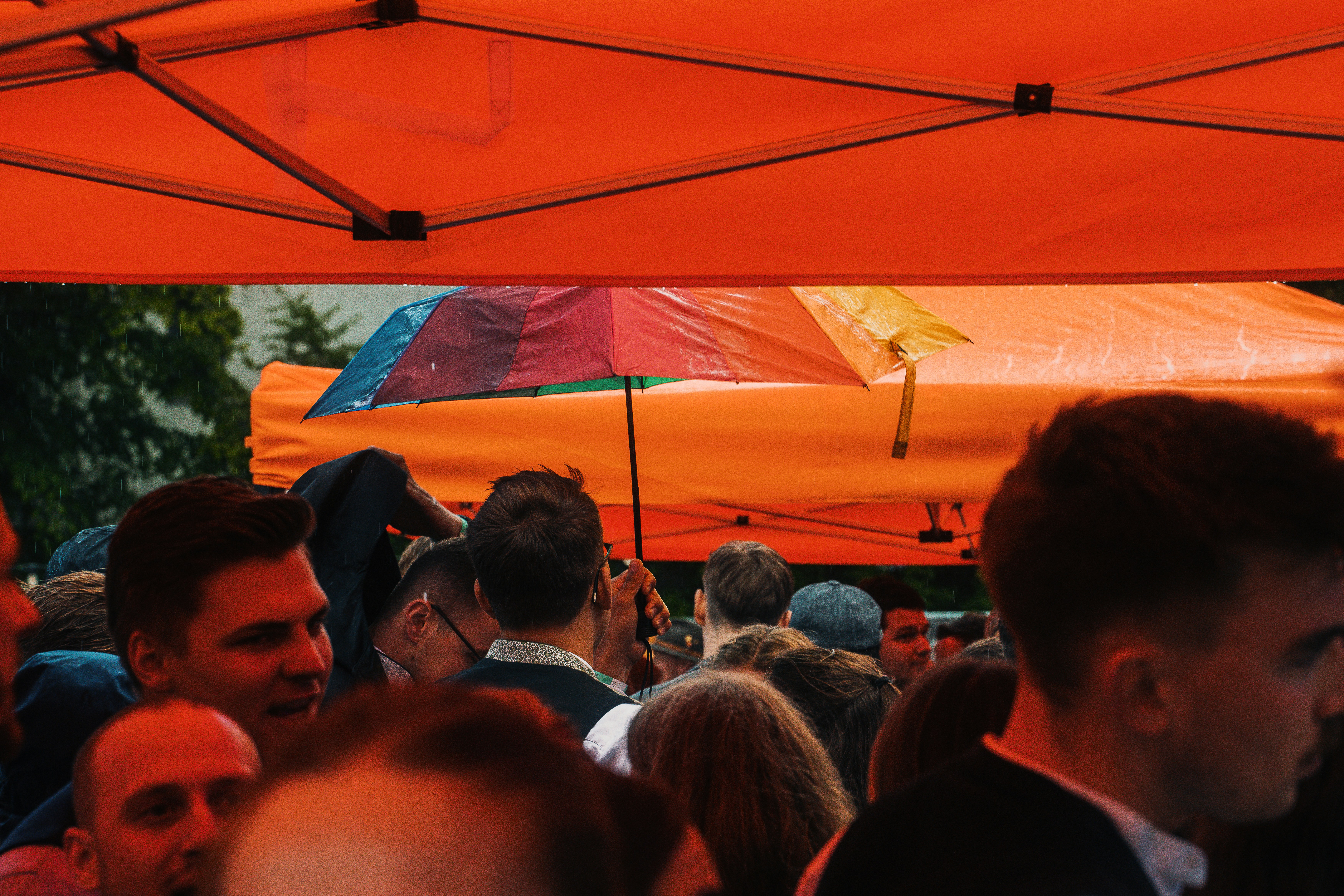 Under the Orange Canopy: A Dense Parade of Faces