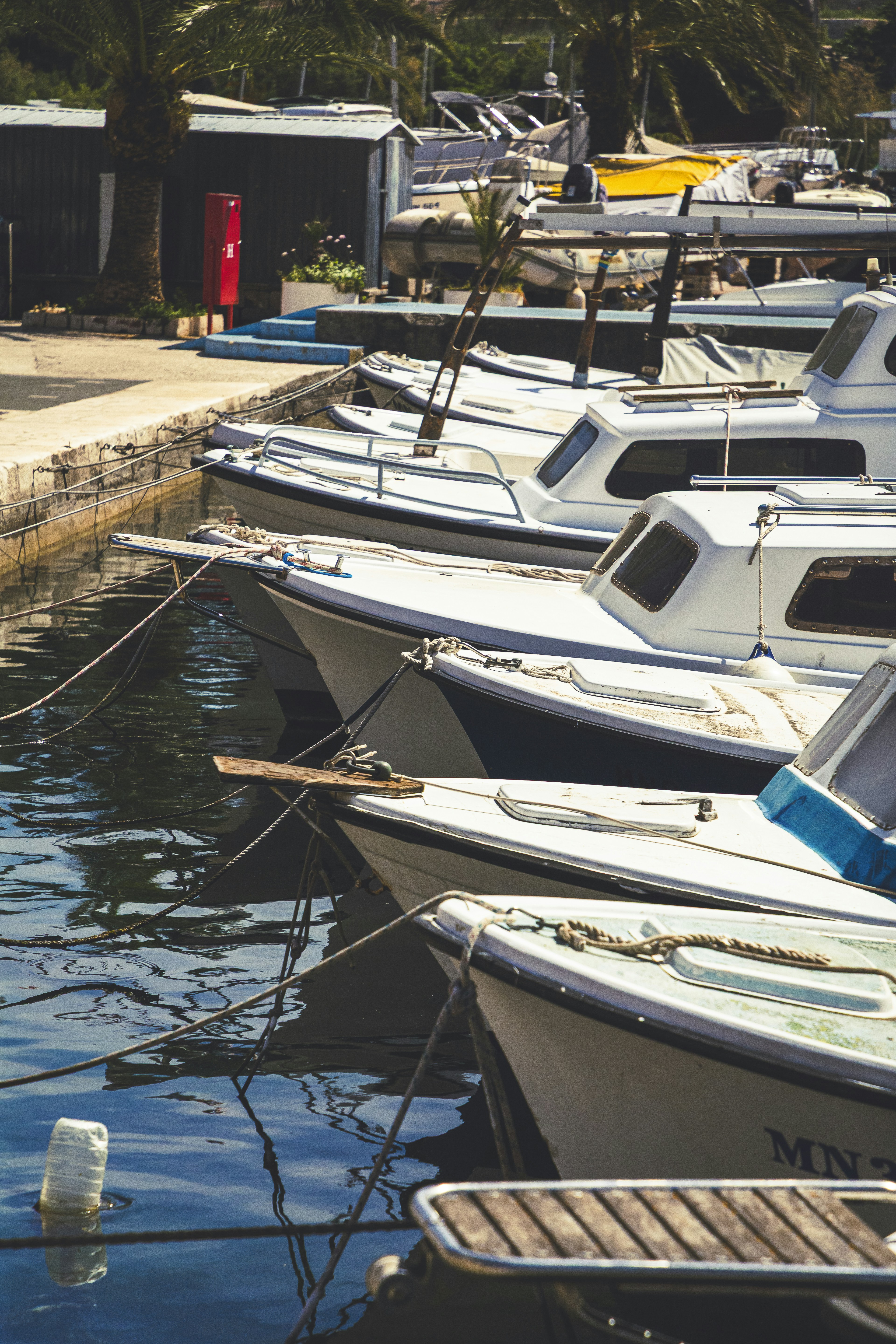 Docked Serenity: A Row of Boats Quietly Rest Along the Quai
