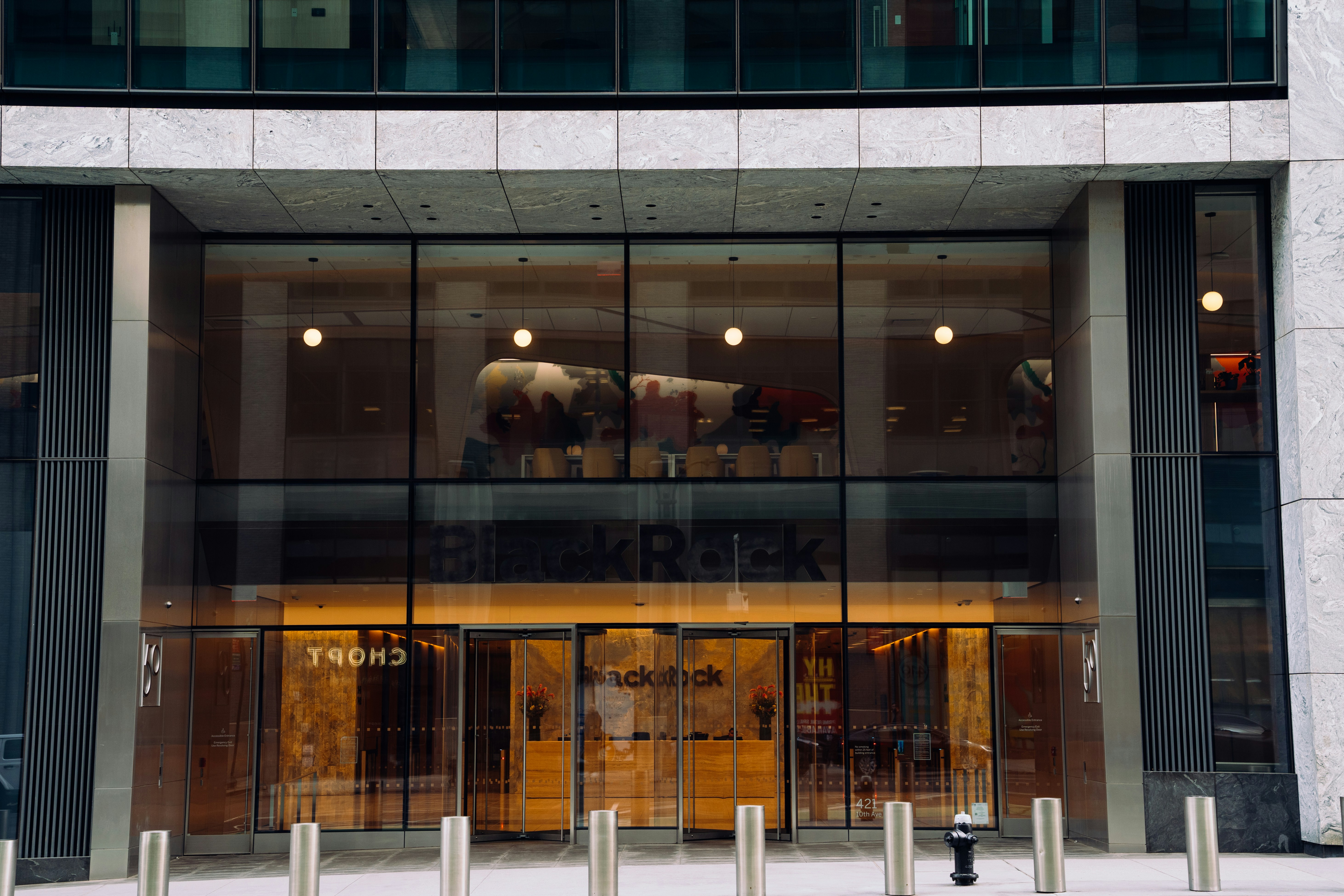 Glass storefront glow: urban shopfront beneath towering glass facade