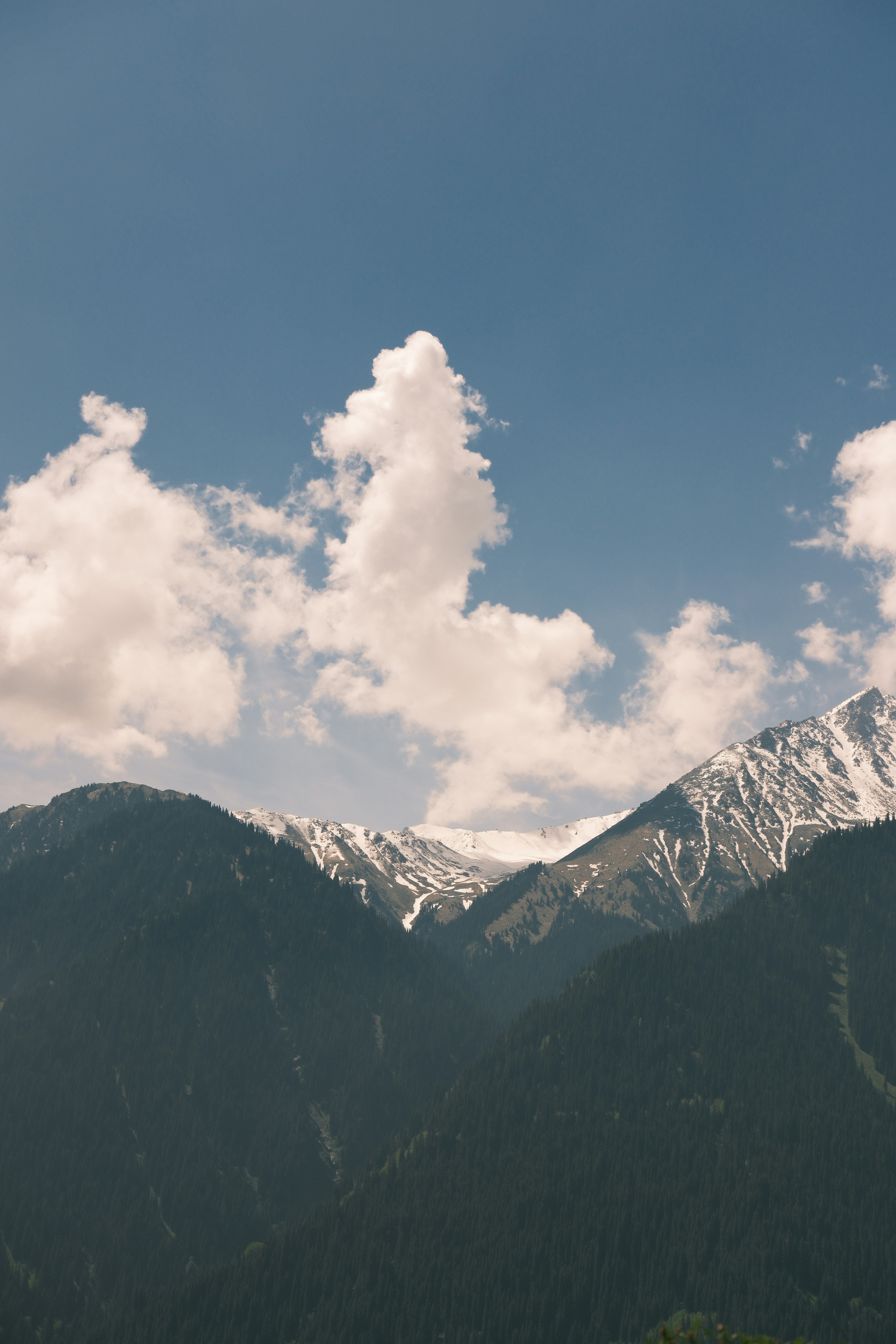 Snow-Crowned Peaks Beneath a Quiet Sky