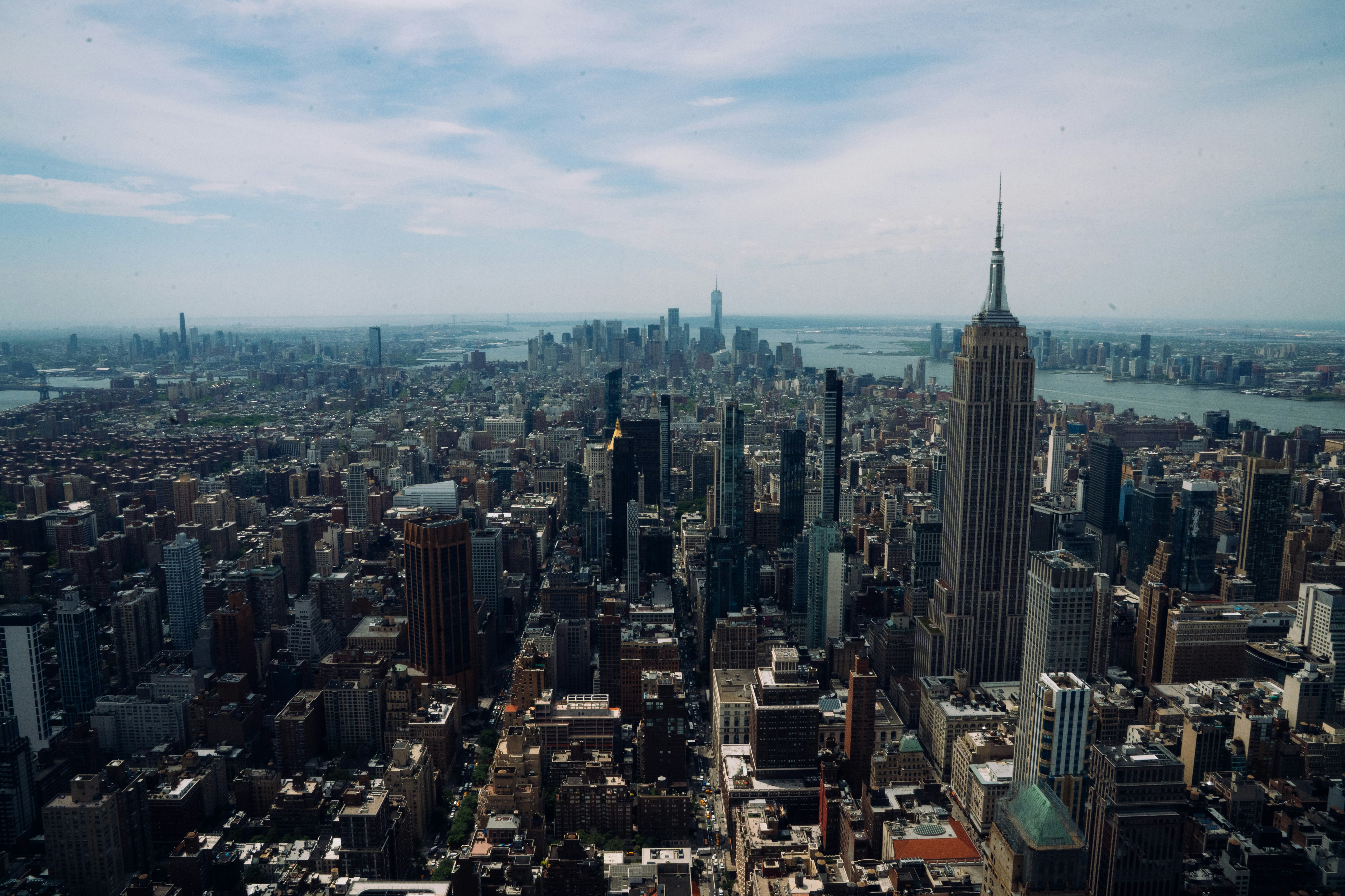 Skyline Pulse: Empire State Silhouette Over a Bustling Grid