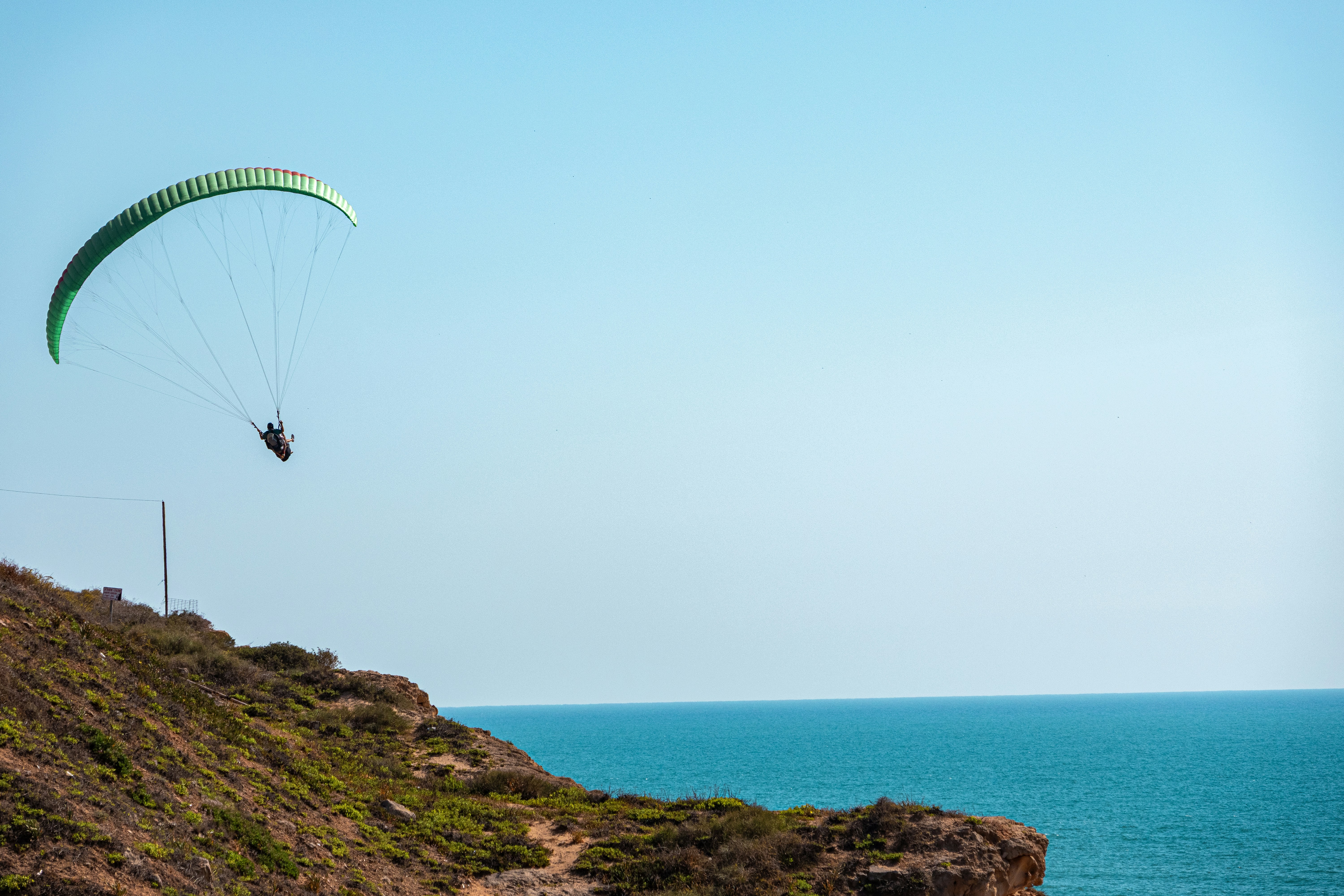 Soaring Rider Against the Cliffline