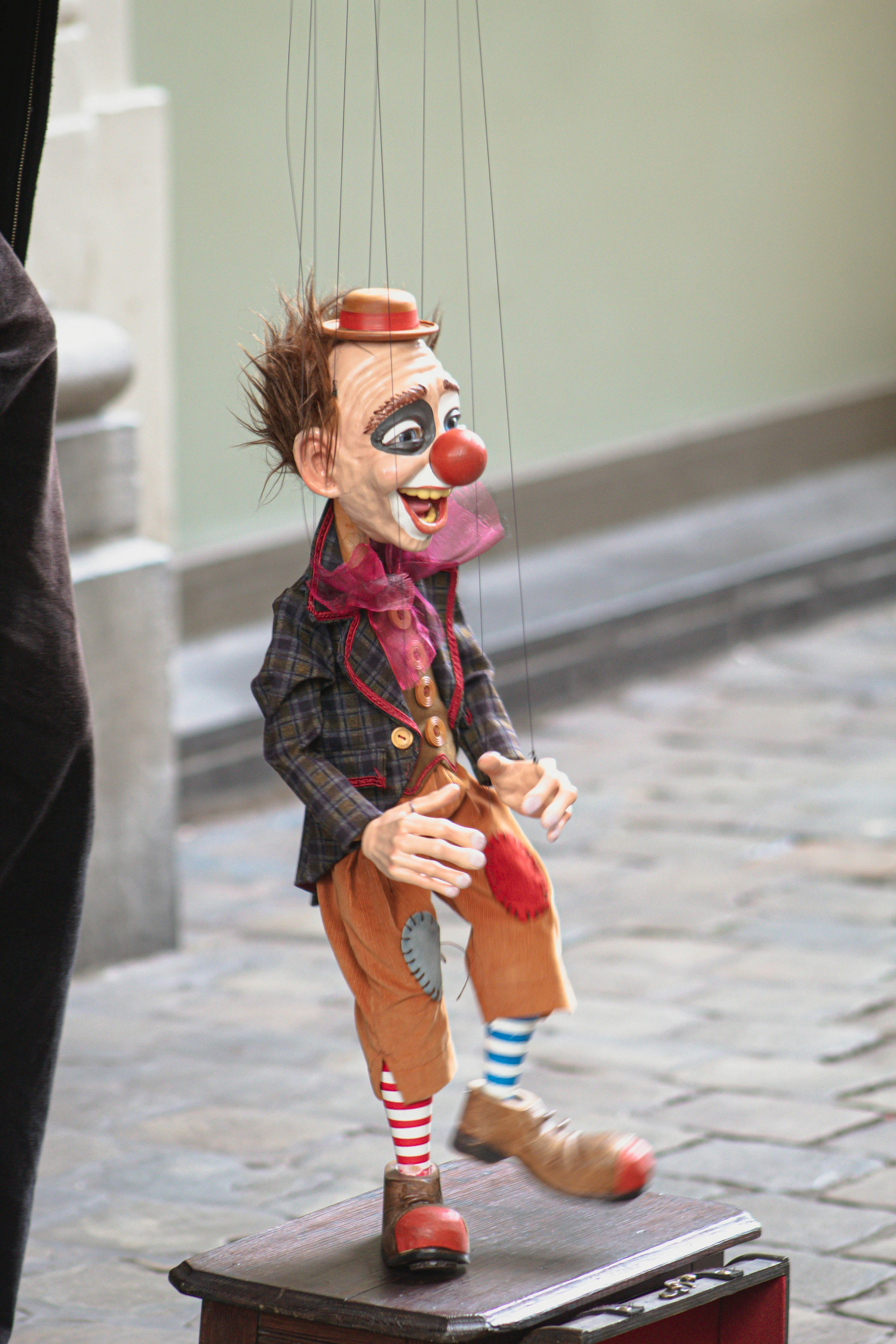 String-Pulled Marionette on a Cobblestone Stage