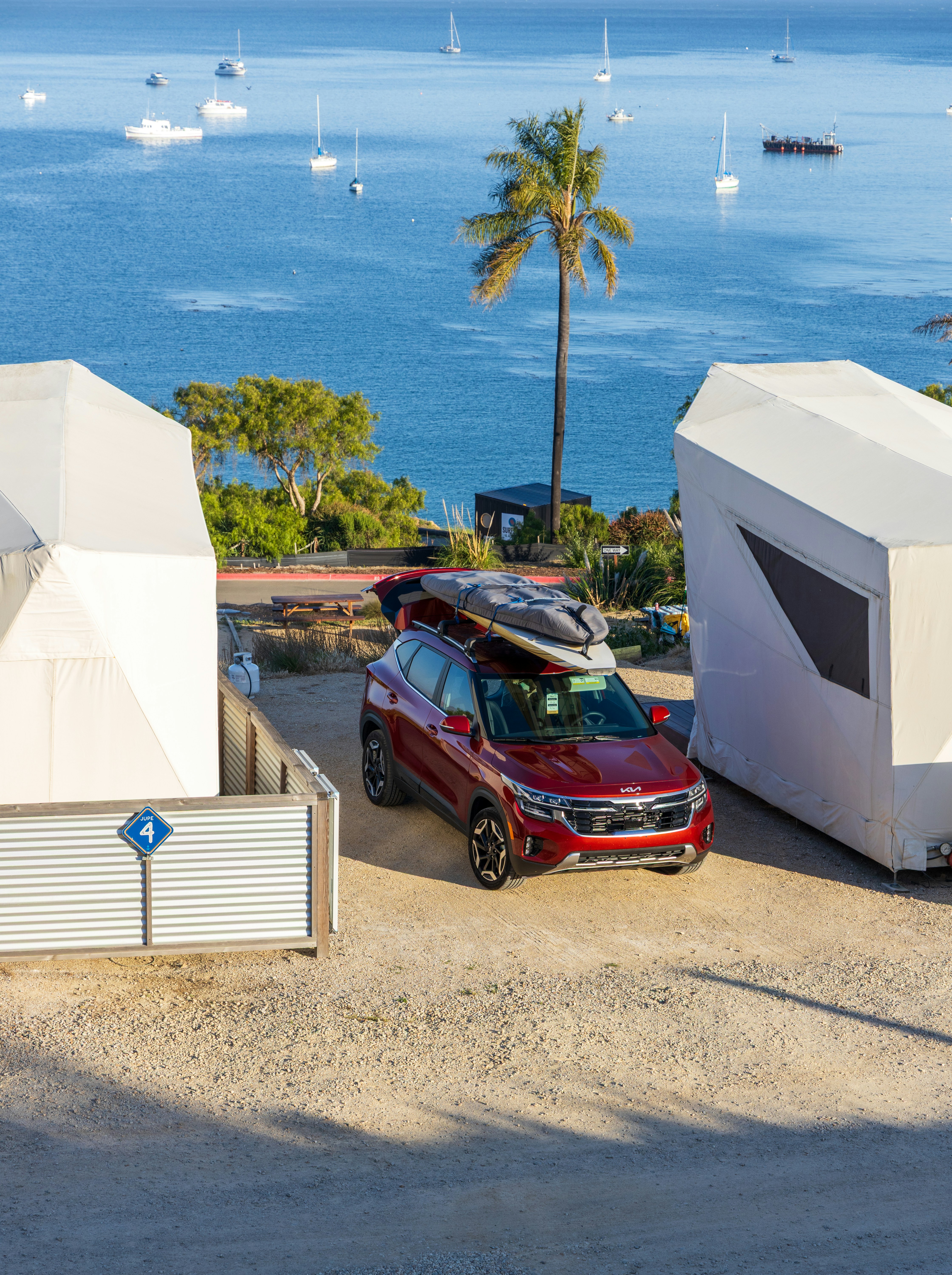 Red SUV with Surf Gear at Coastal Campground