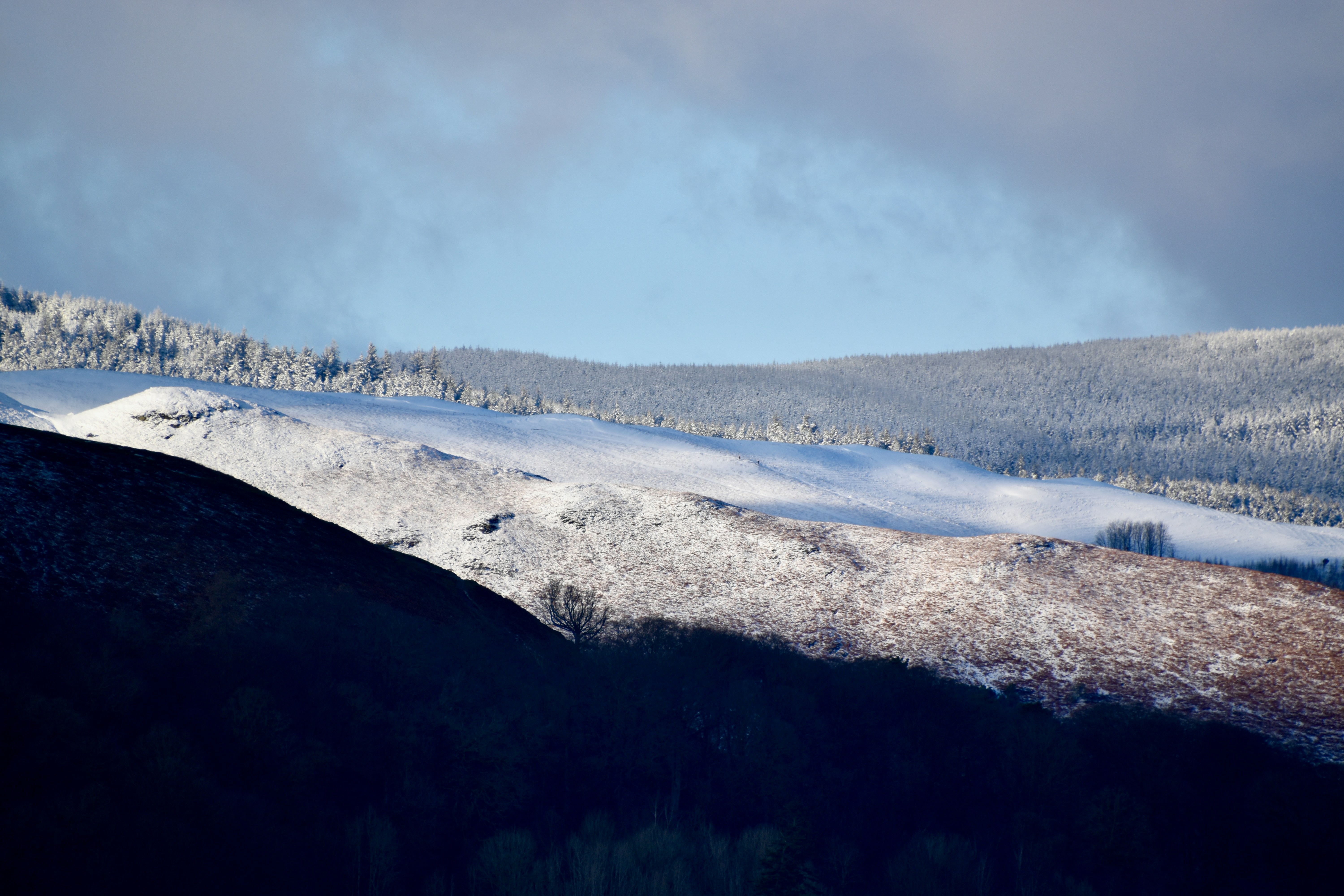 Snow-Capped Ridge Under a Quiet Sky