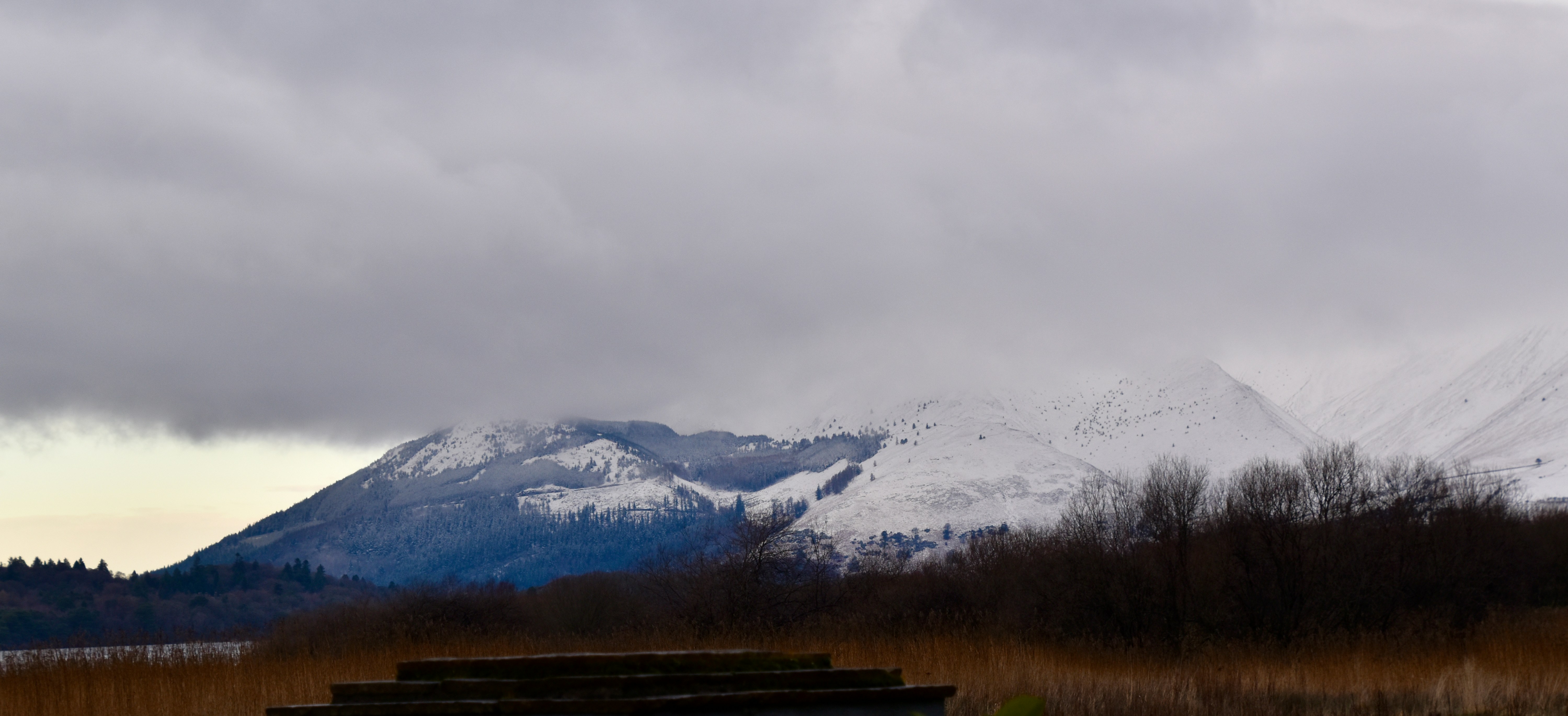 Snow-Kissed Ridge Under Clouded Dawn