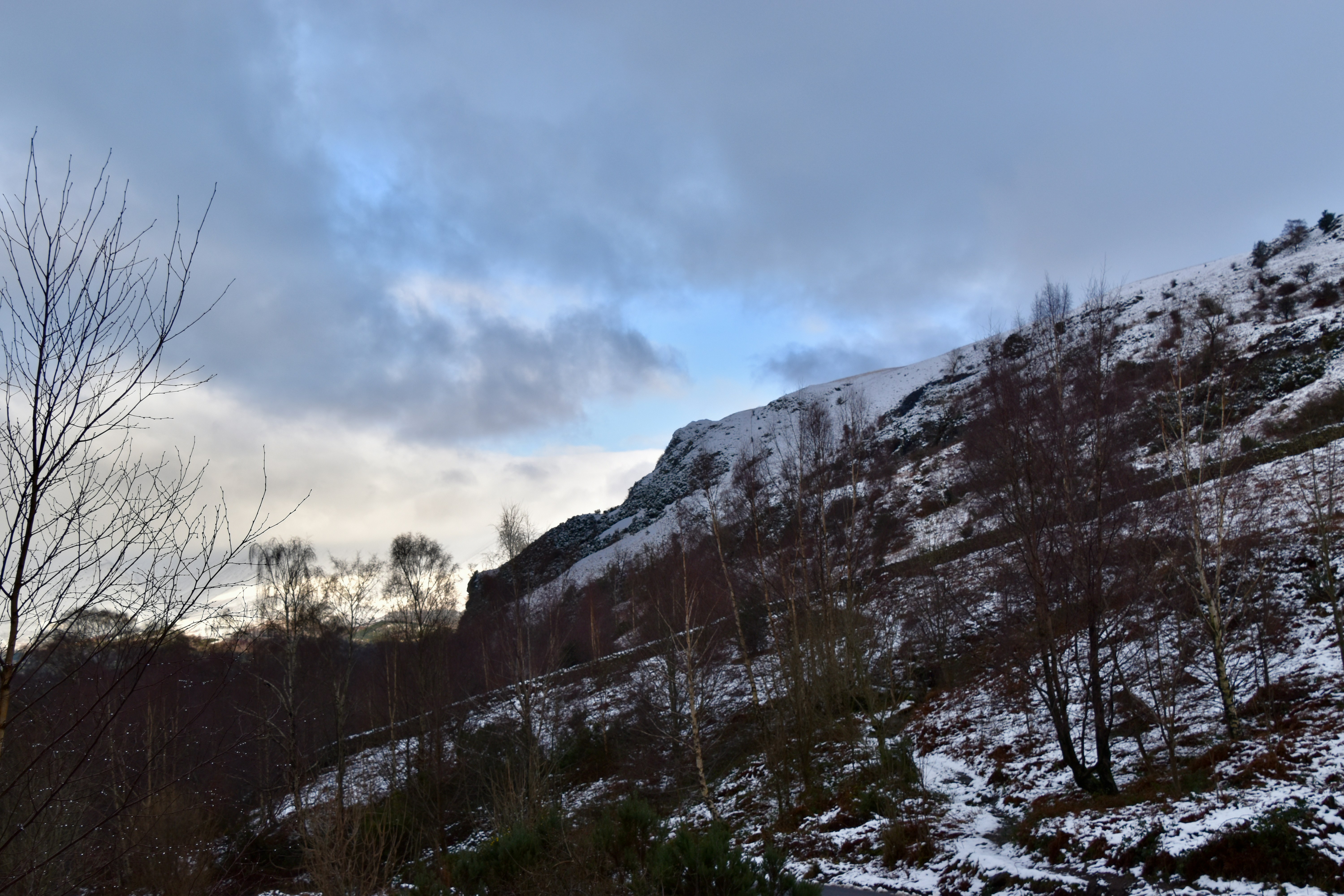Snow-kissed ridge under a yawning sky