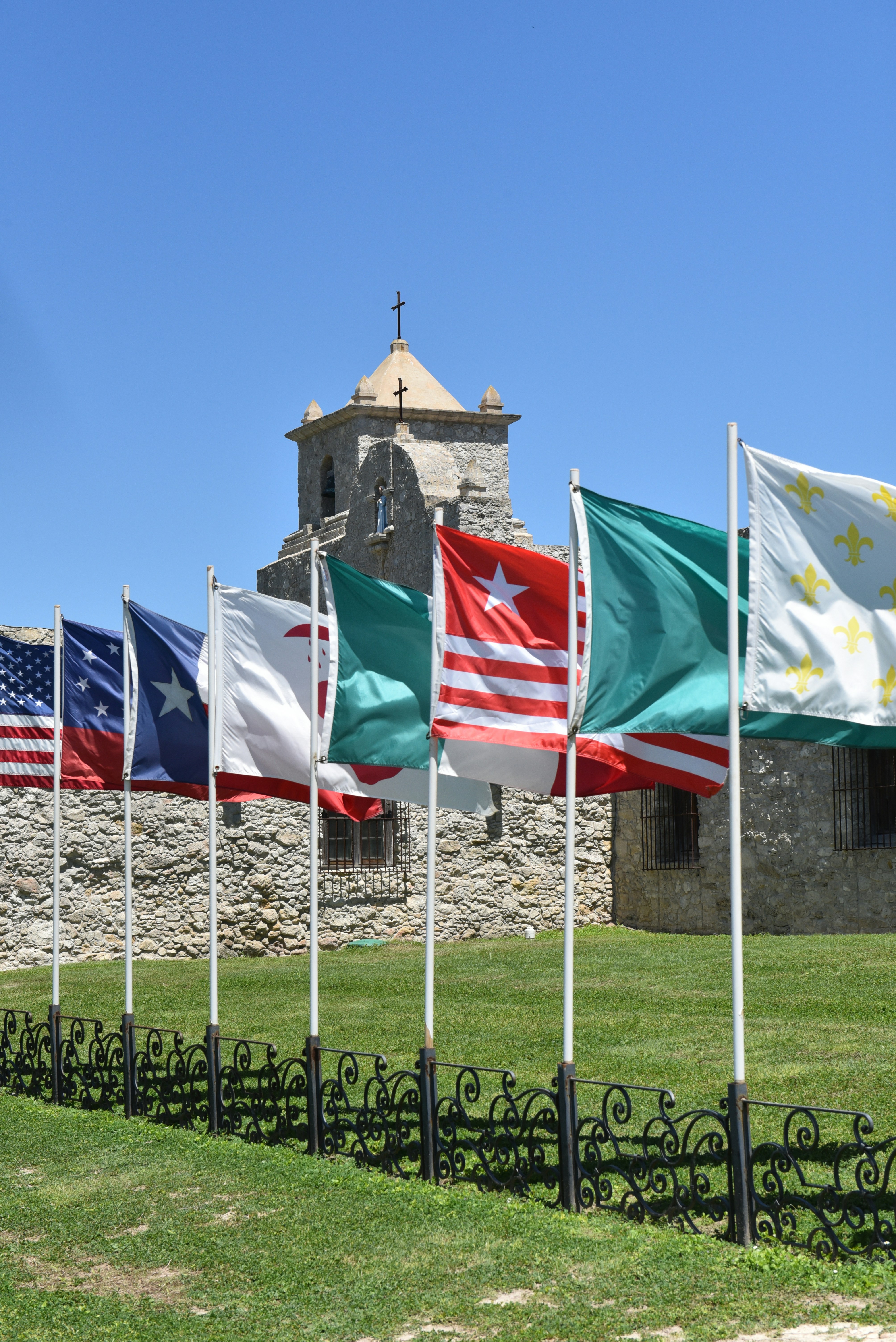 Flags of Unity: A Row of International Banners Against a Stone Fortress