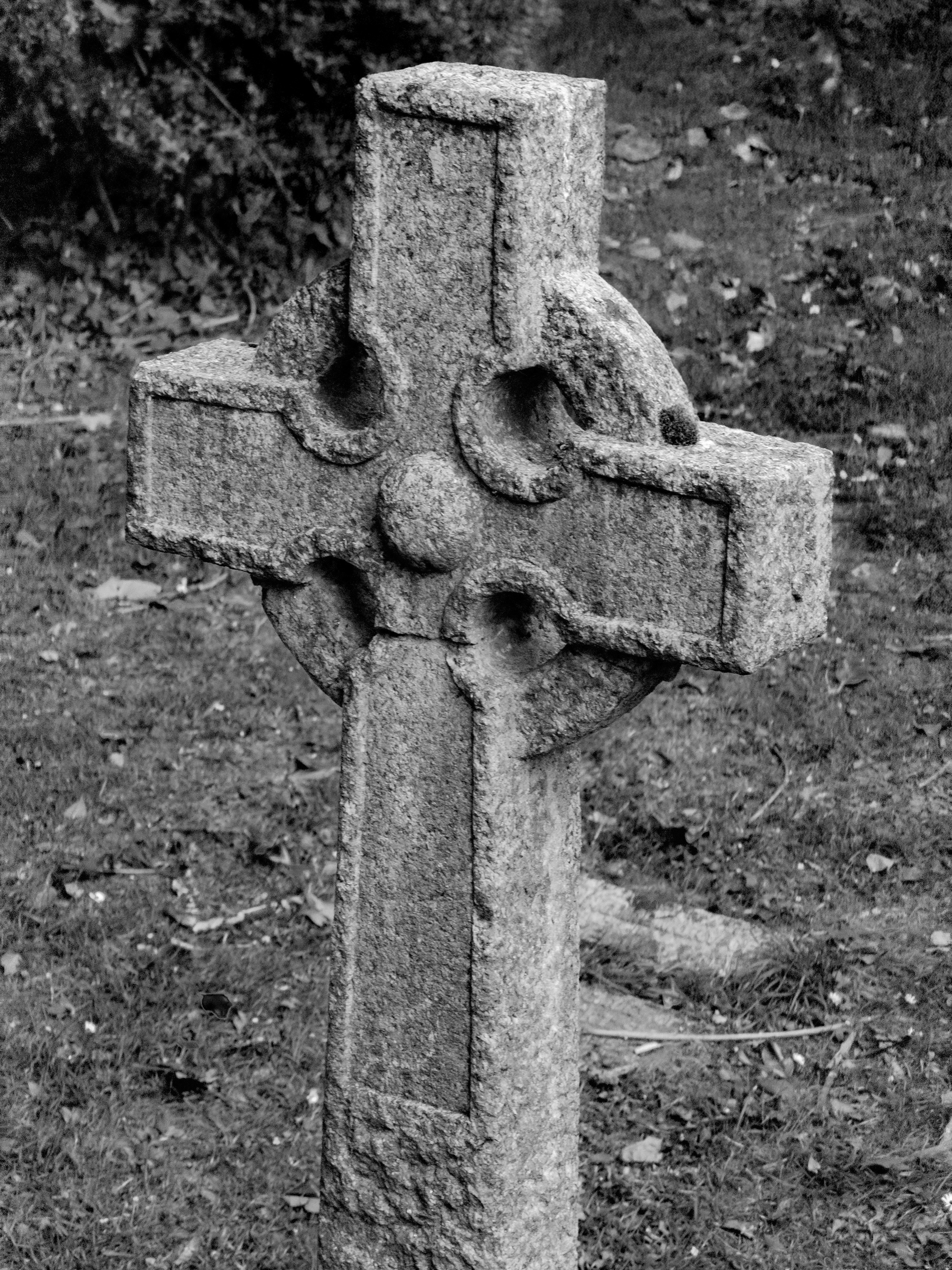 Weathered Rosette Cross Standing Guard Over the Quiet Ground