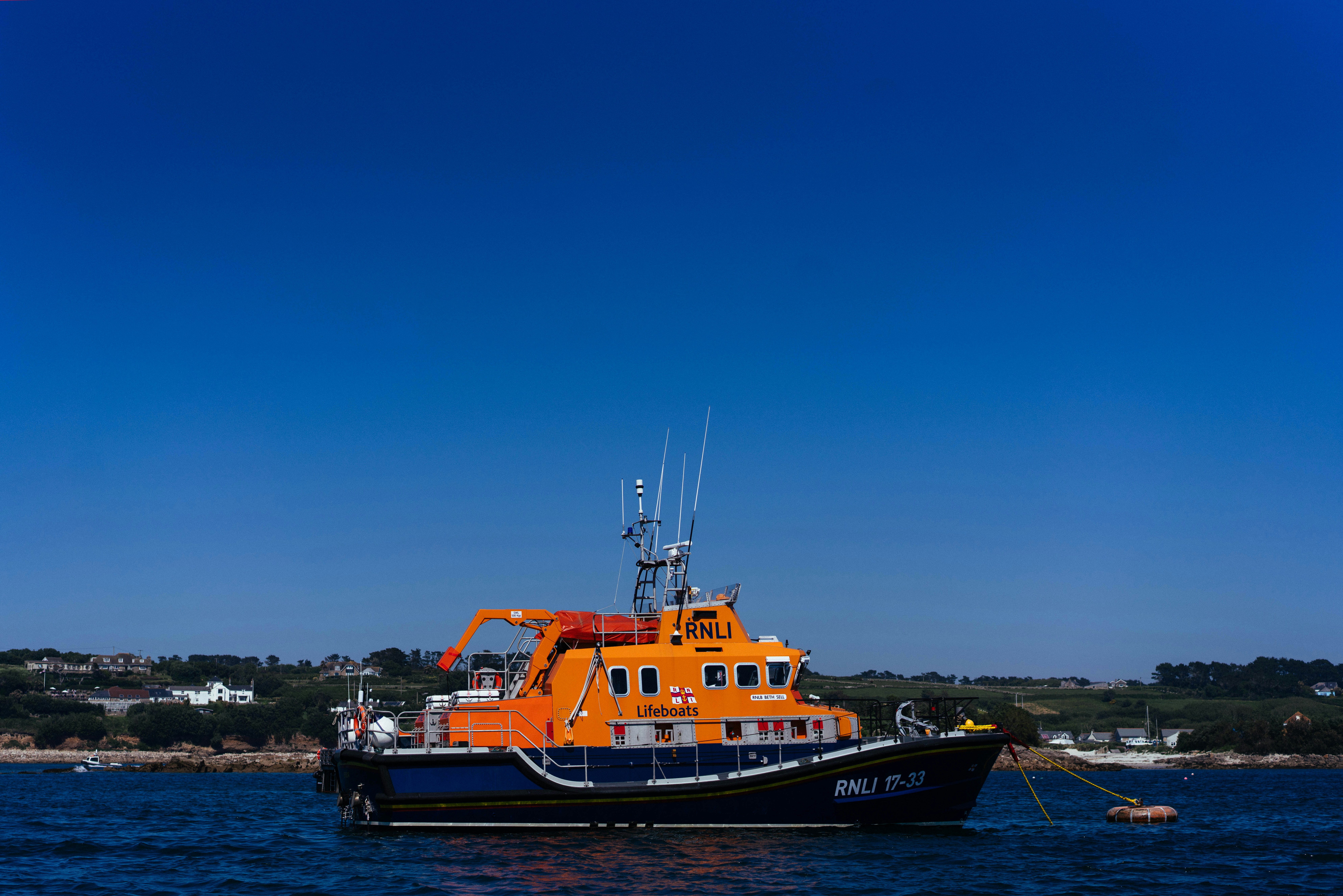 Orange Coast Patrol: A Vessel Anchored Against a Calm Blue Horizon