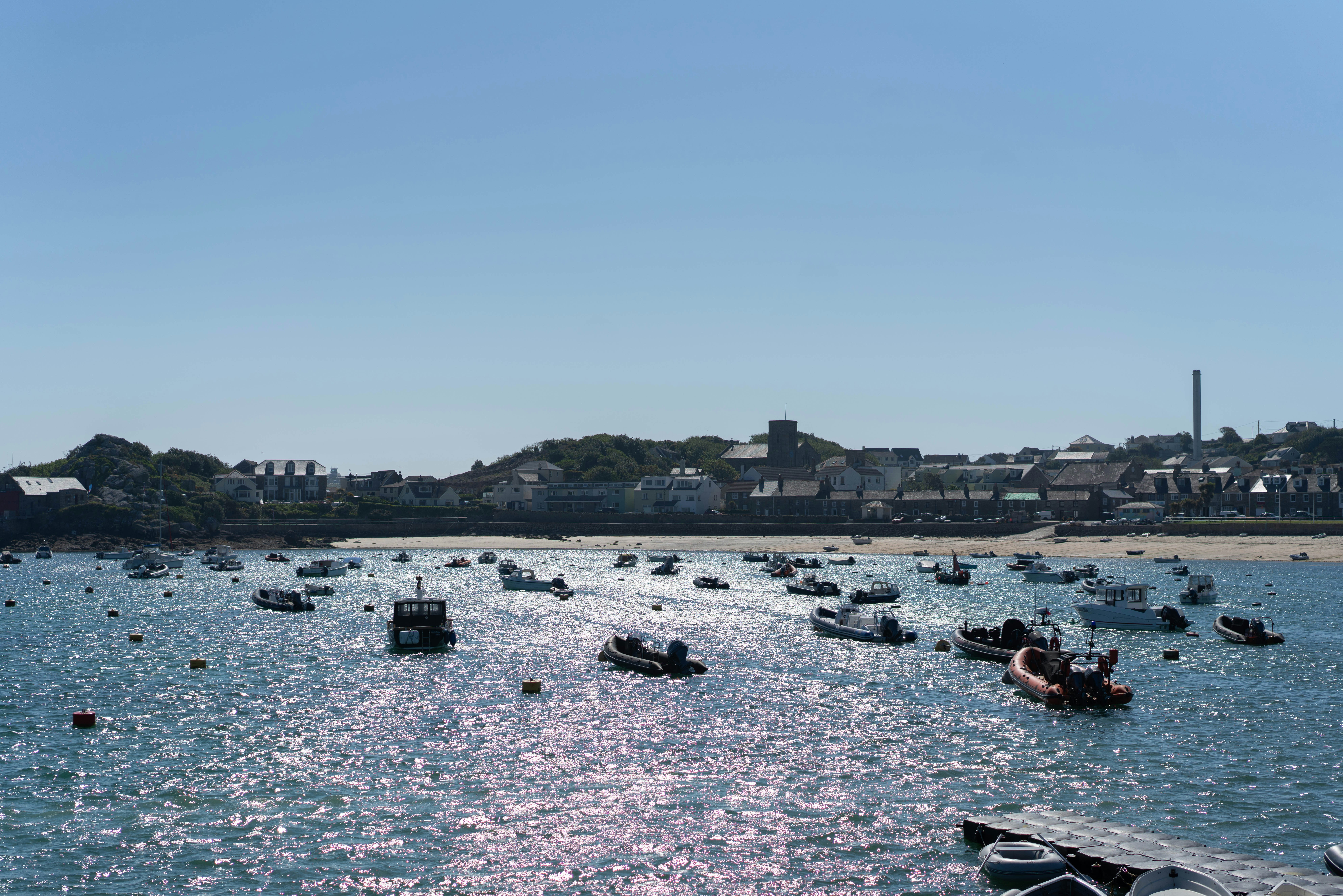 Sunlit Harbor: Small Boats Dancing on a Quiet Tide