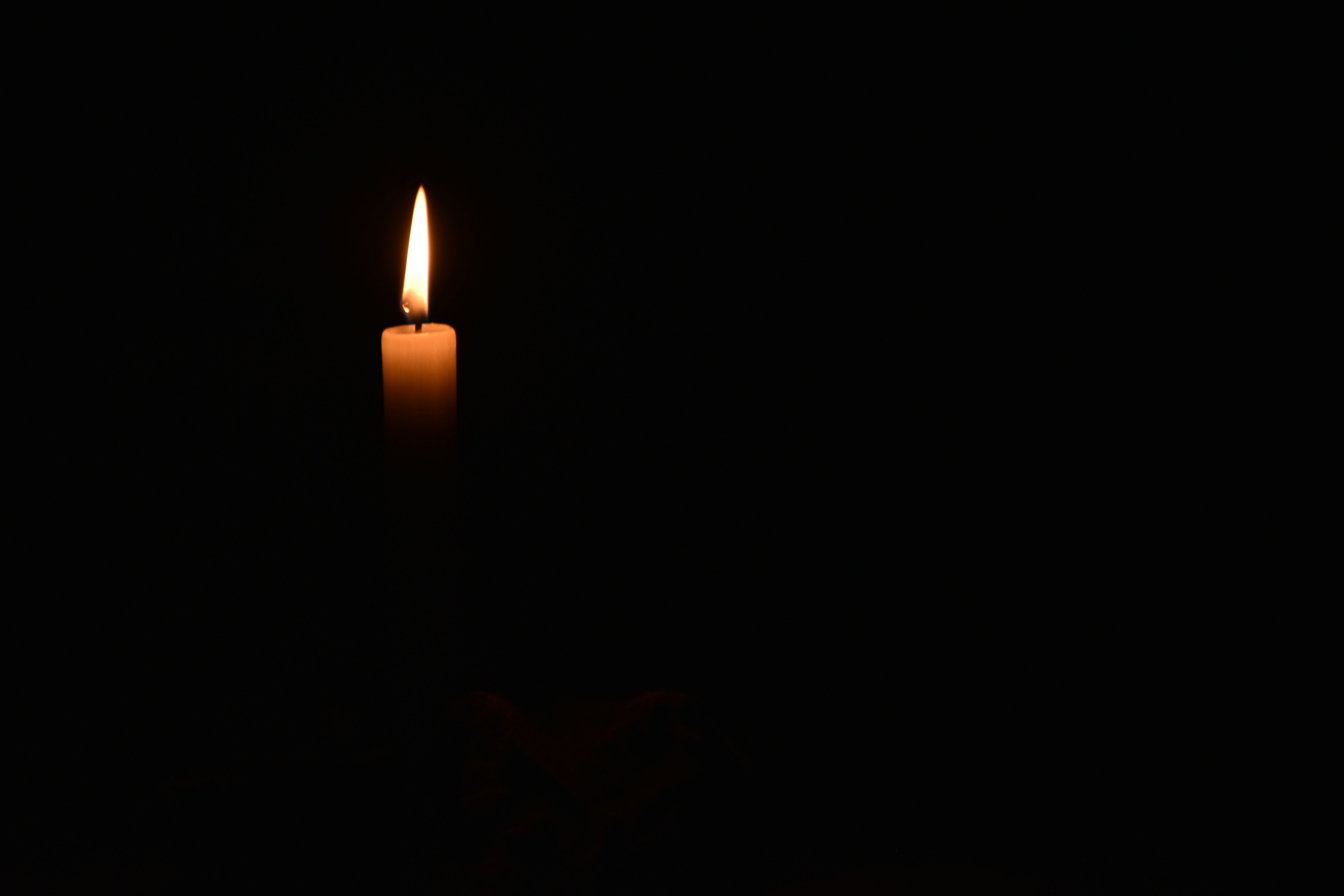 Single Candle Flame in a Sea of Night