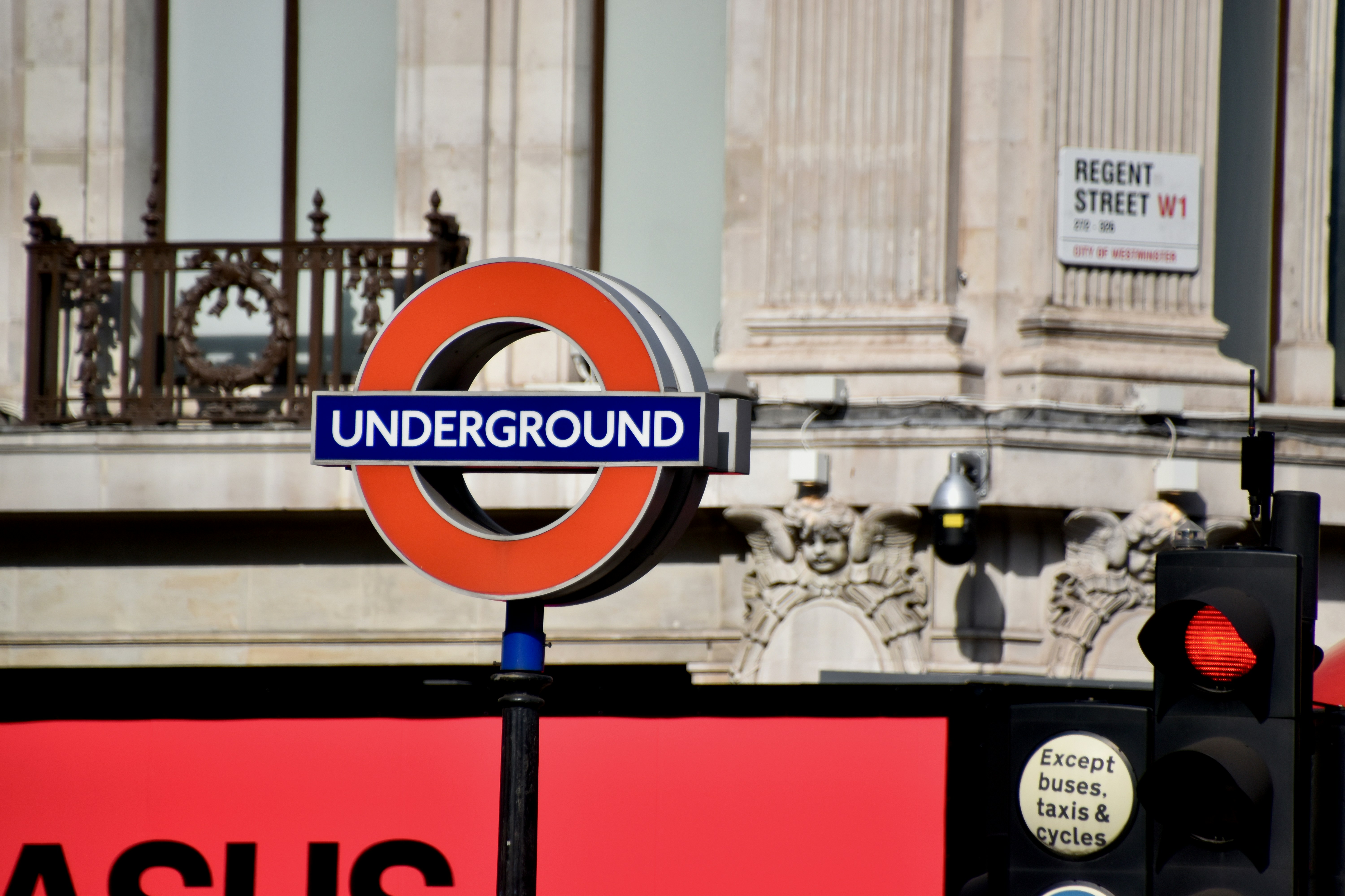 Underground Emblem: A Suburban Red Sign Against Classic Facades