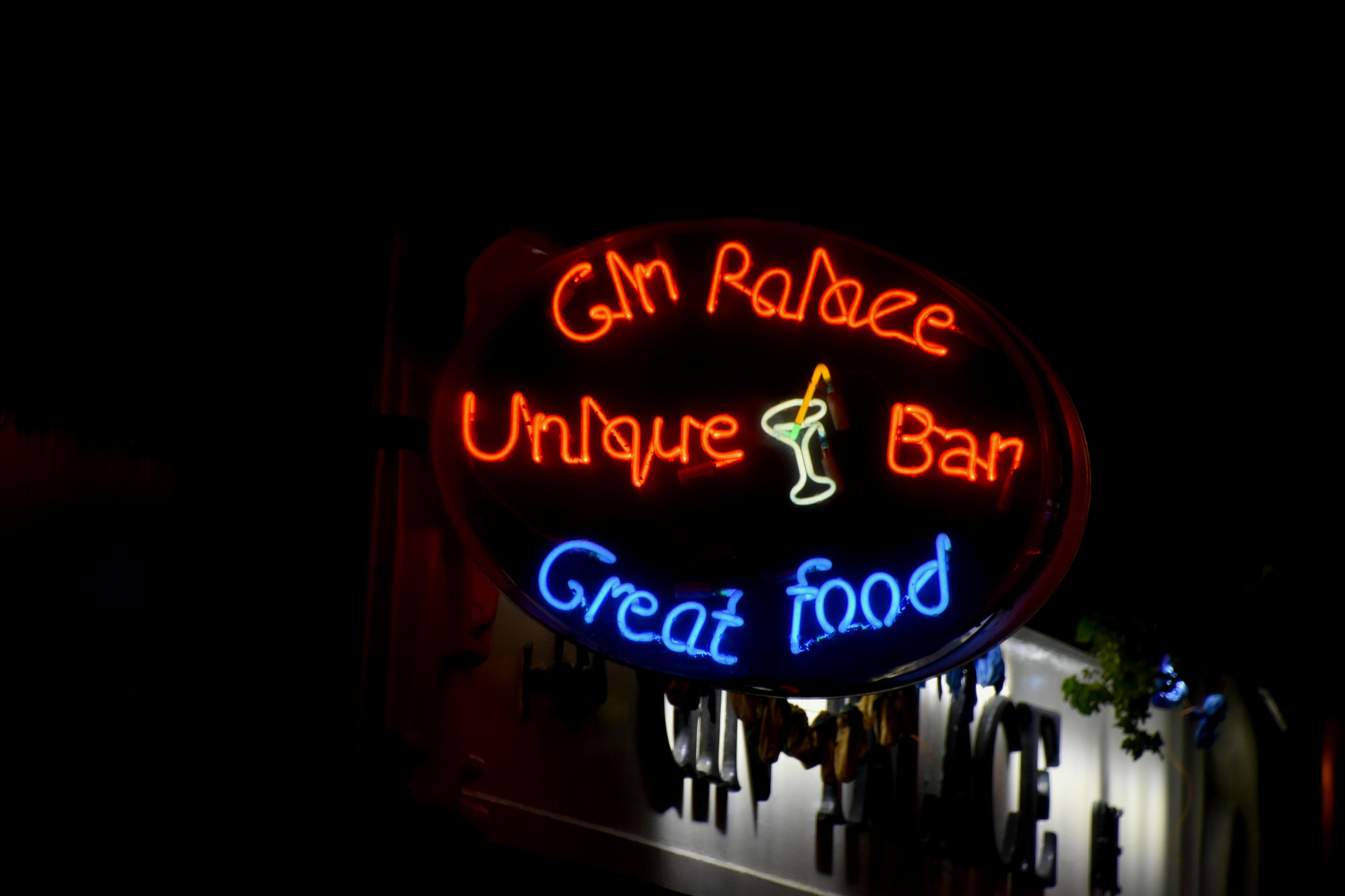 Neon Spotlight: Great Food sign above a Darkened Barfront