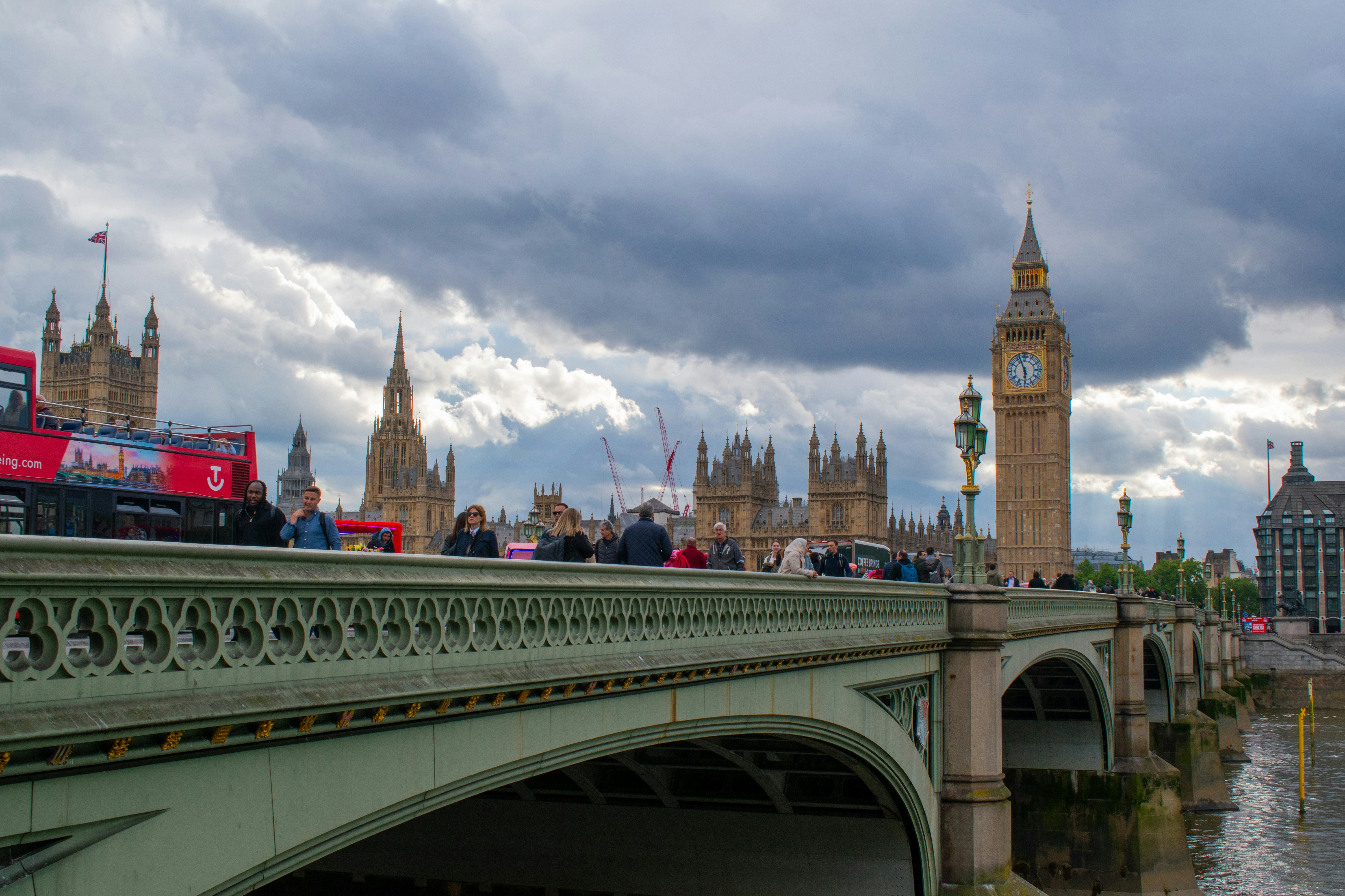 London’s Riverfront Parade: Tourists on Westminster Bridge with Big Ben Rising