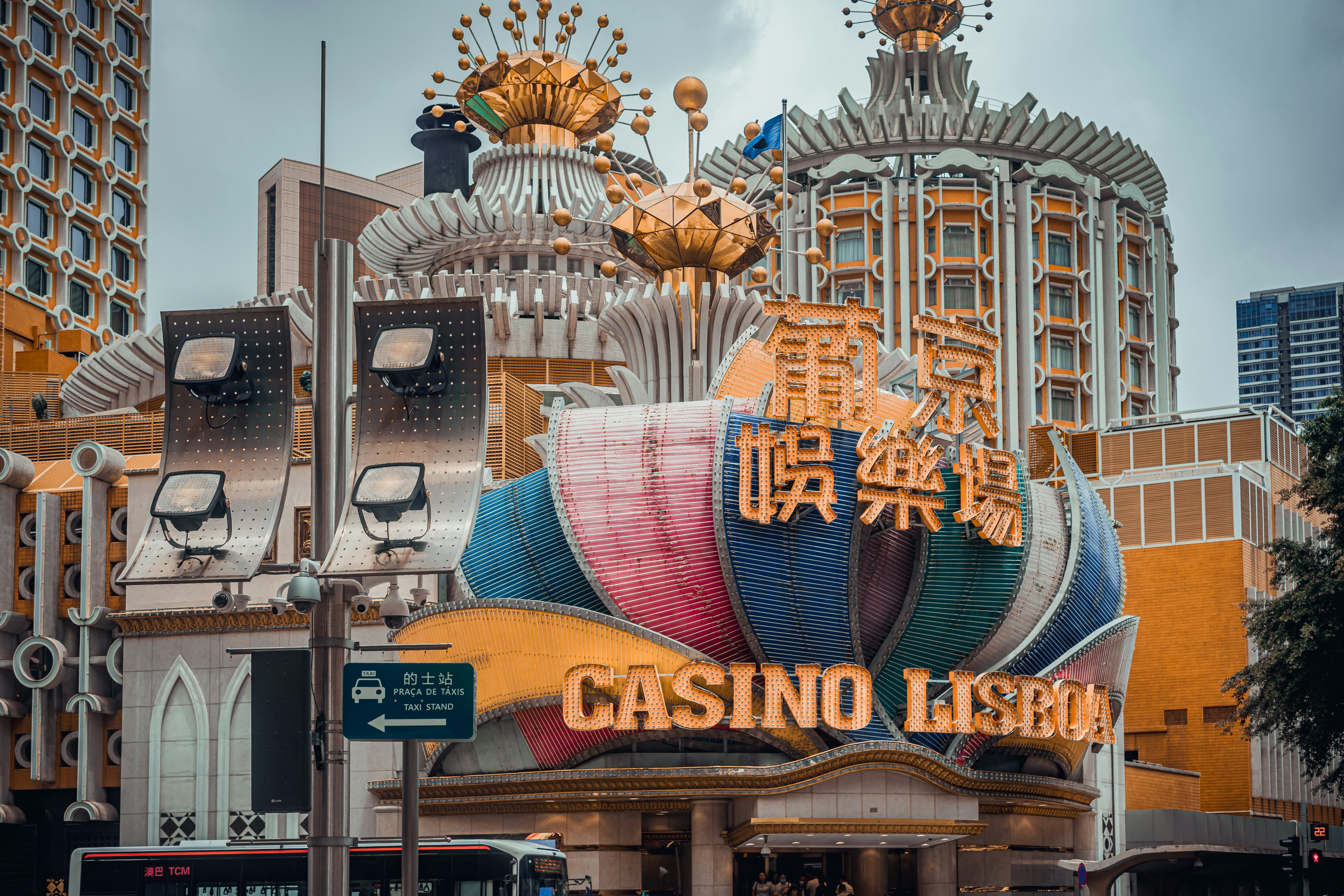 Neon Mosaic: Casino Lisboa’s Enigmatic Facade Under Urban Skies