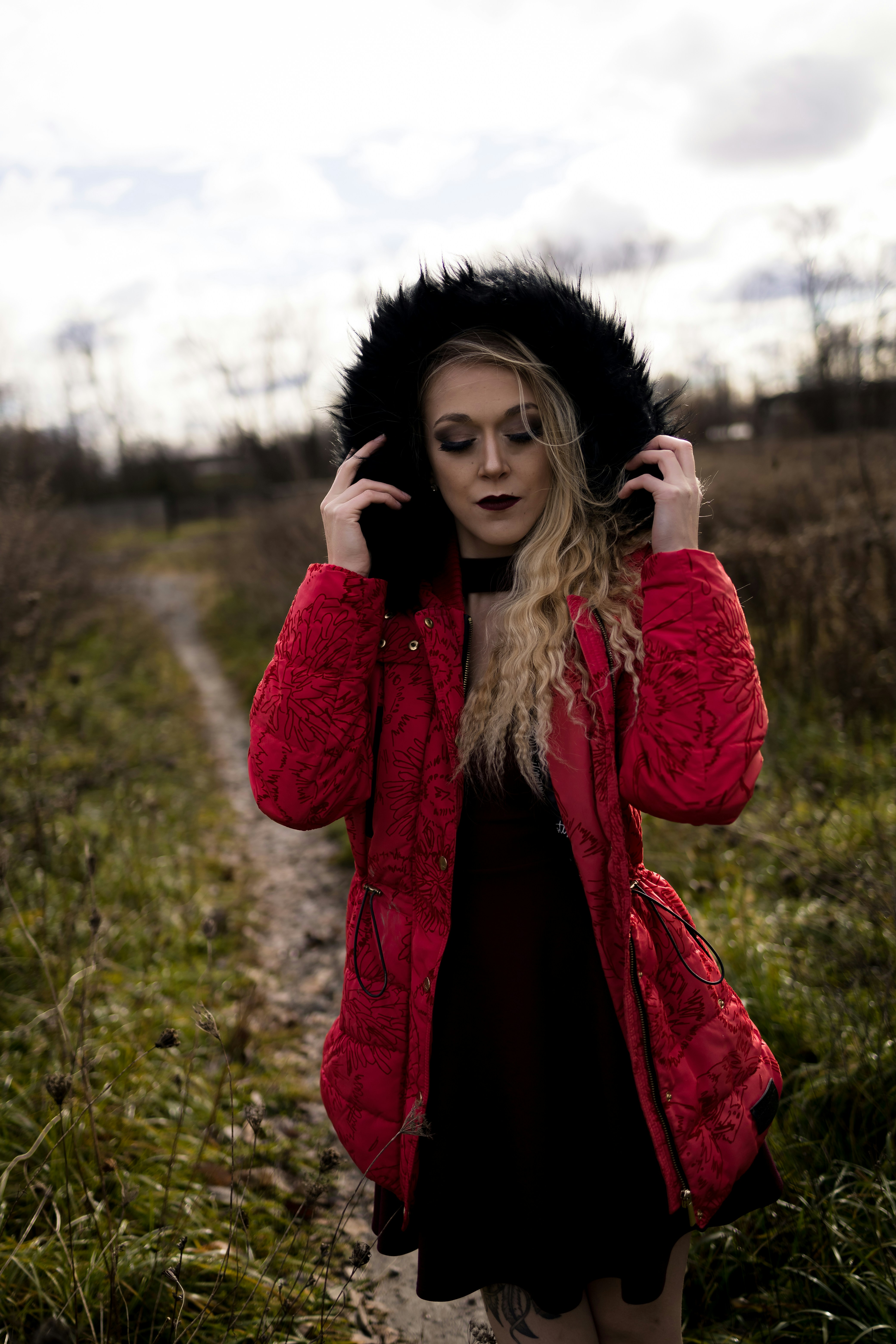Crimson Winter: A Portrait in the Wind-Soaked Path