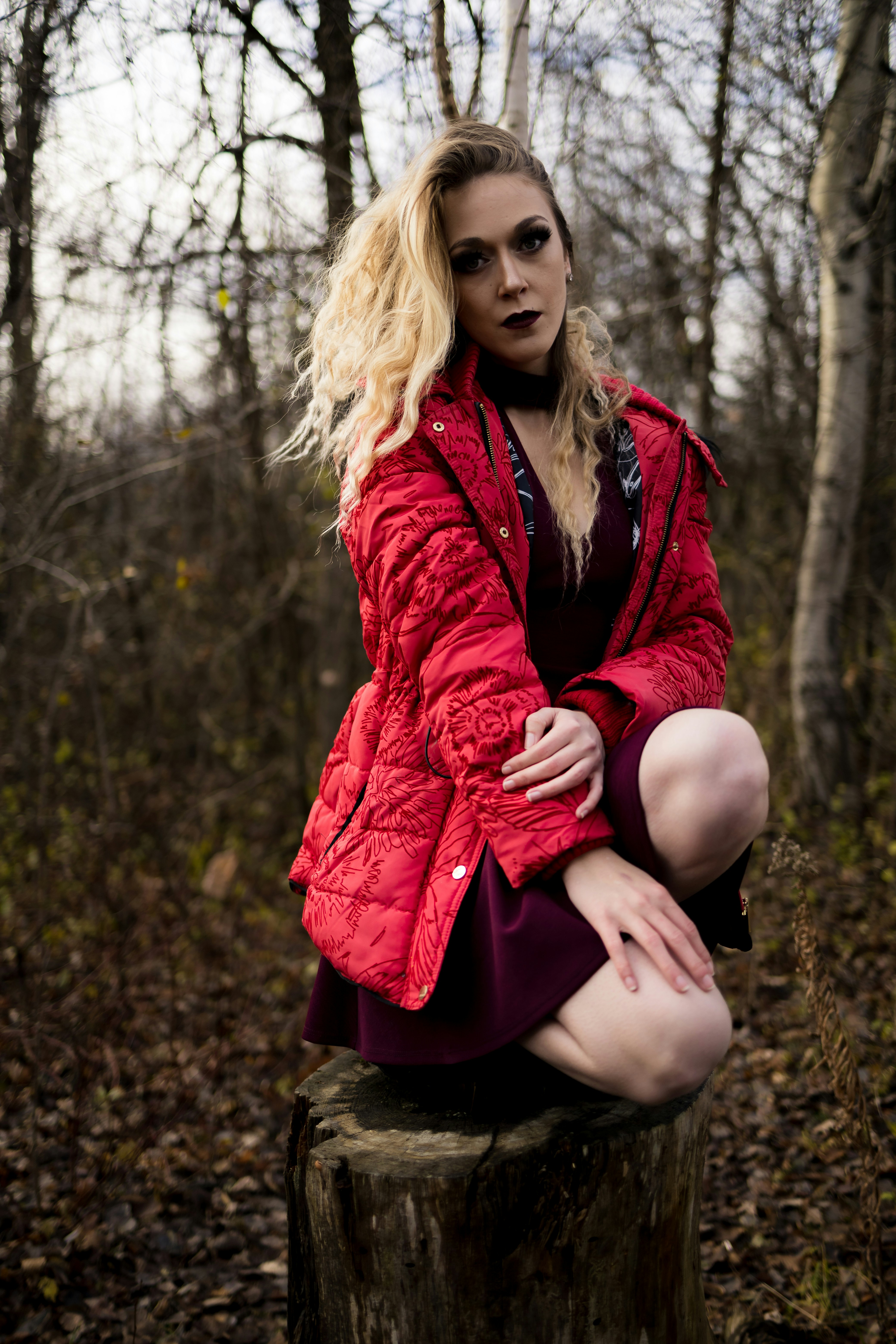 Red Jacket, Quiet Forest: A Portrait on a Weathered Log