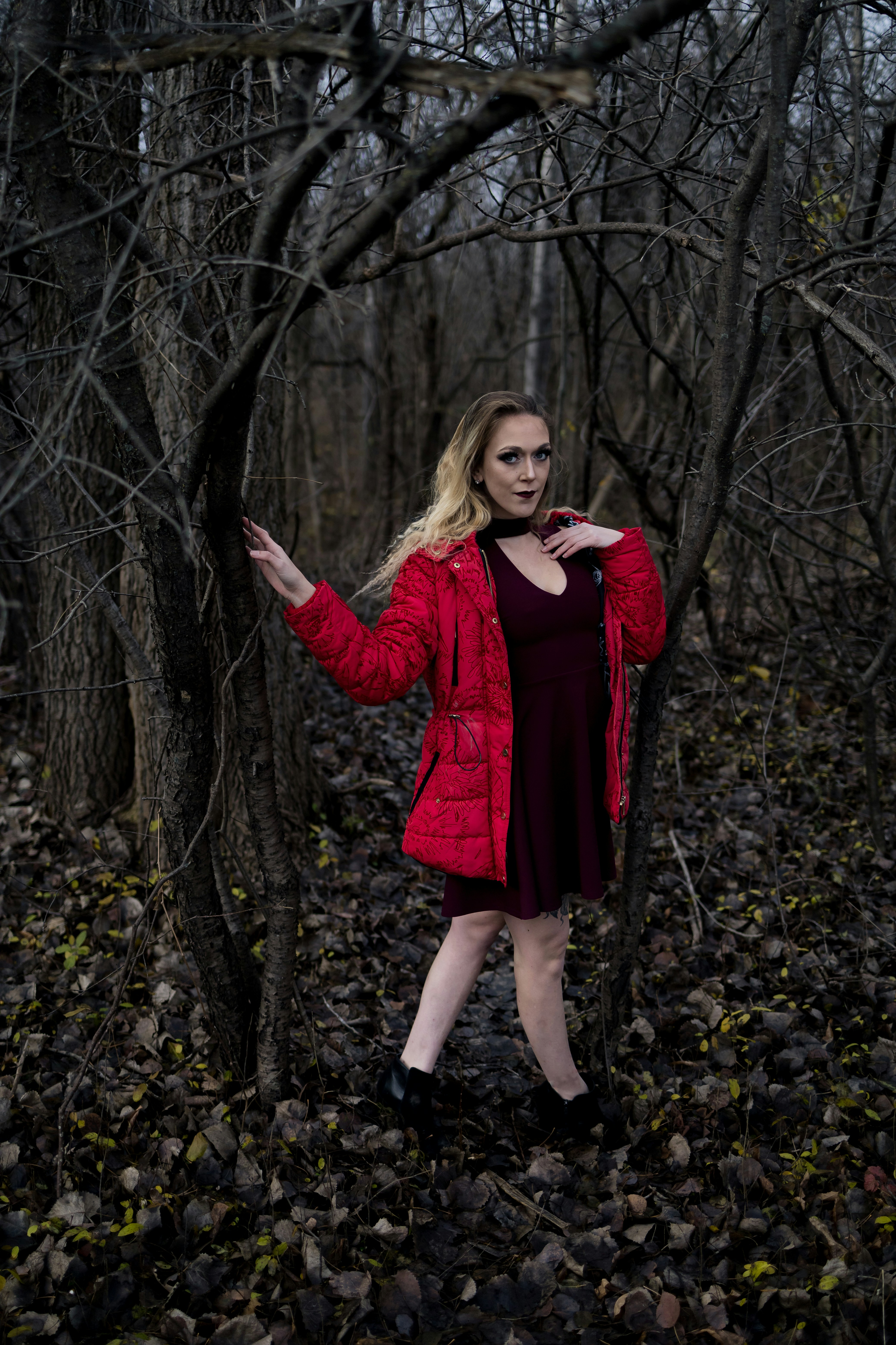 Crimson jacket in a leaf-strewn forest glade