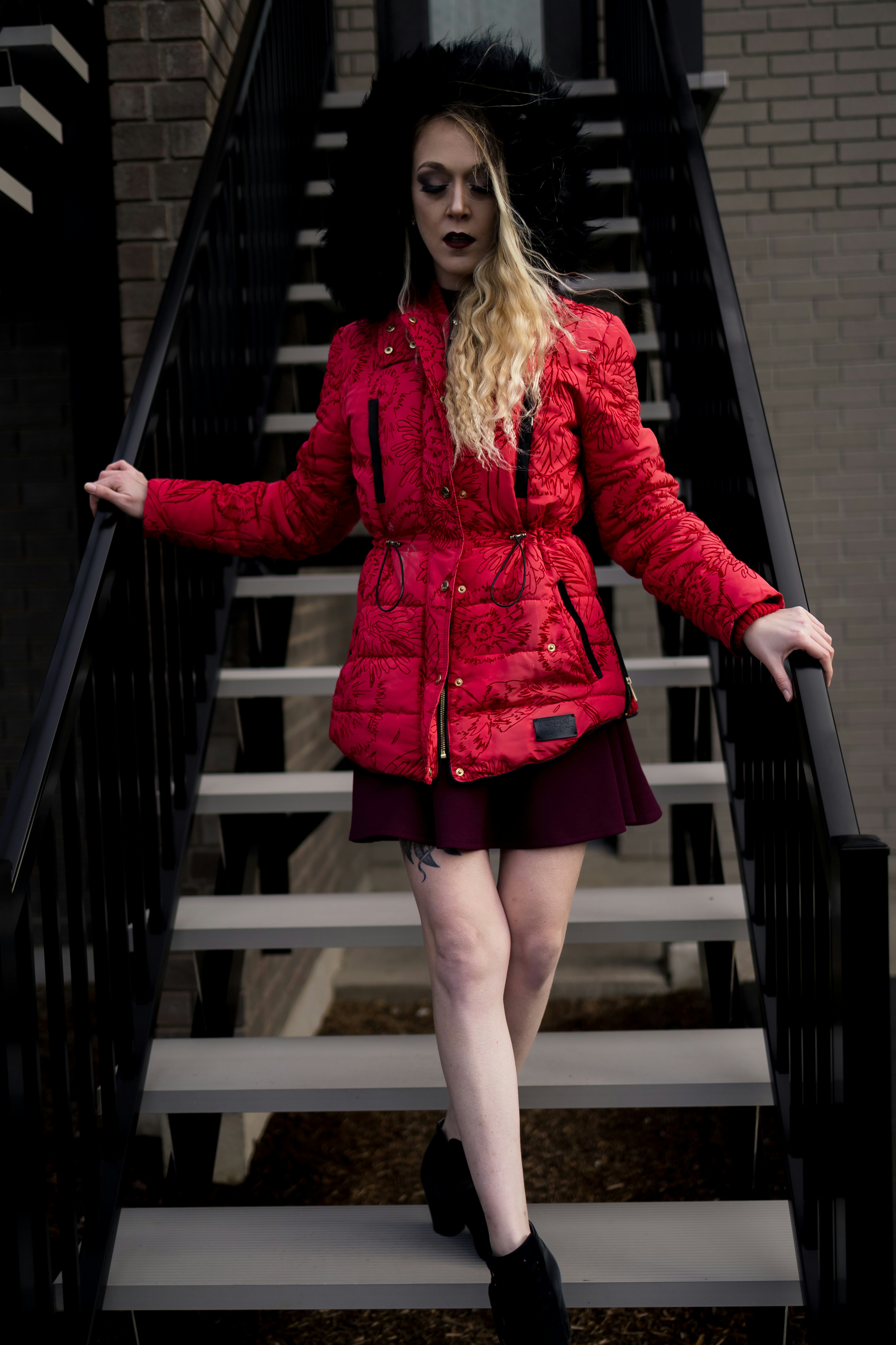 Red Pulse on the Steps: A Velvet Coat in an Urban Stride