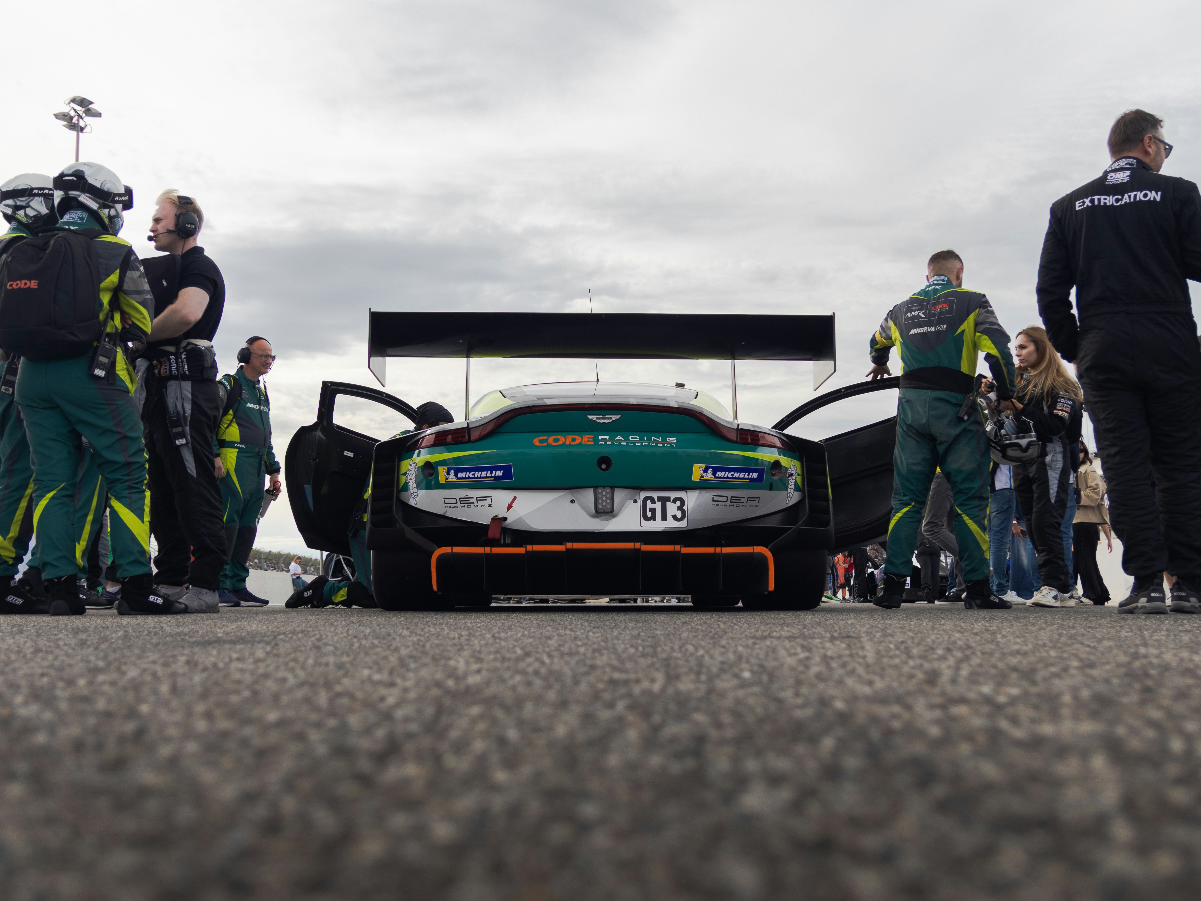 Rear View of a Race GT3 Car in Pit Lane: Engineering Detail and Team Presence