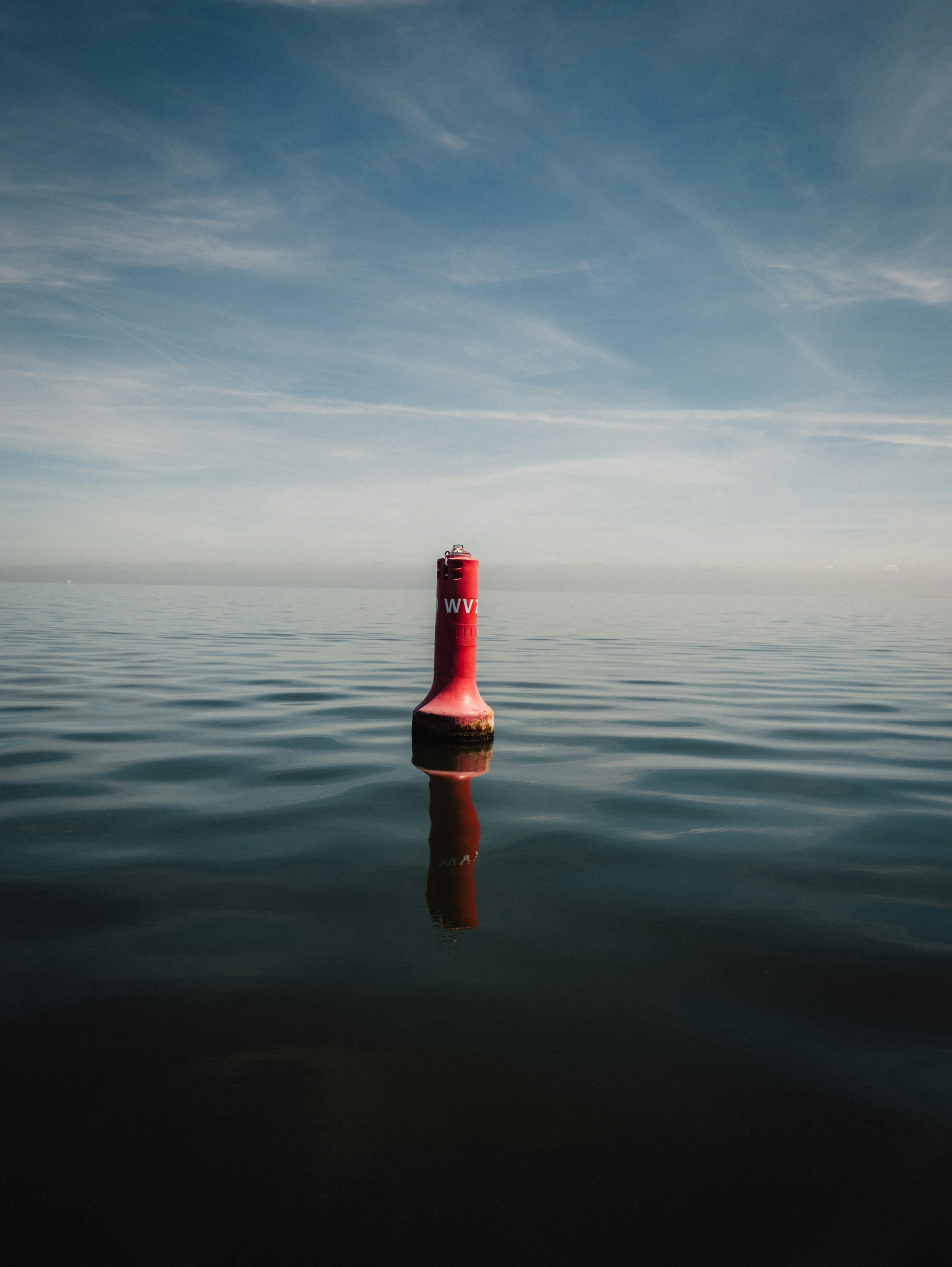 Red Buoy, Quiet Ocean: A Still Moment of Solitude