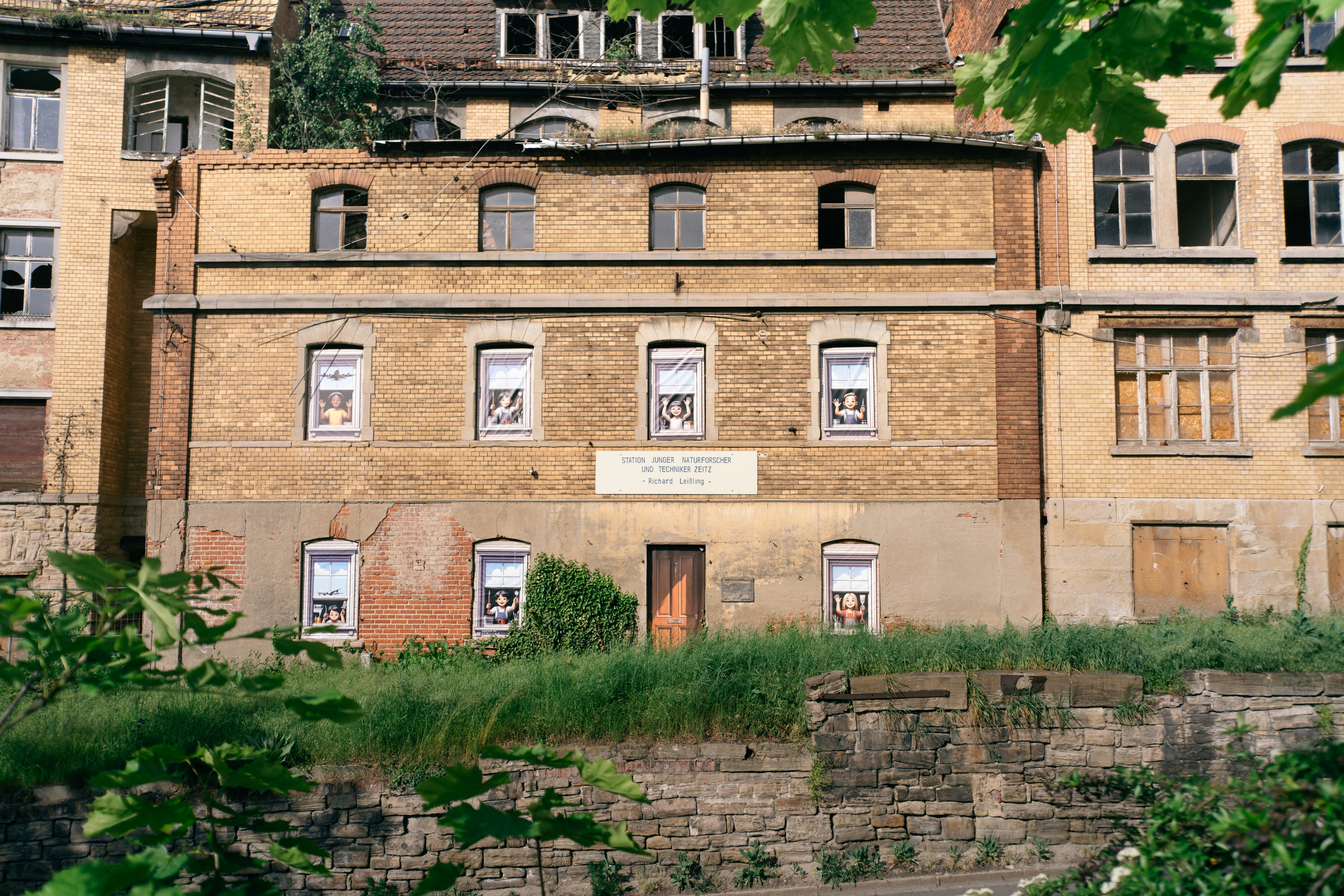 Sunlit University Facade: Brickwork Flags and Framed Windows