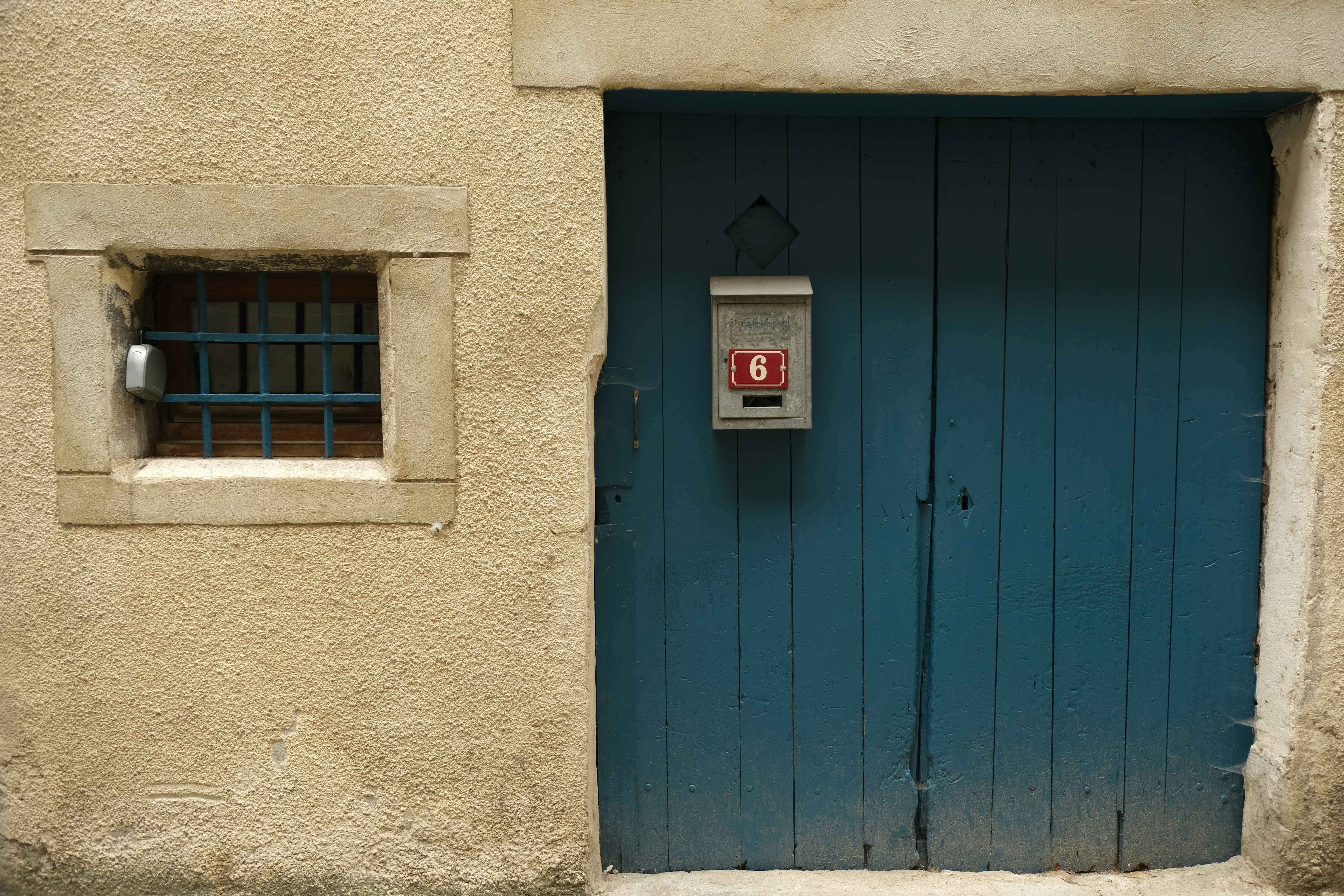 Blue Door on a Sun-bleached Wall