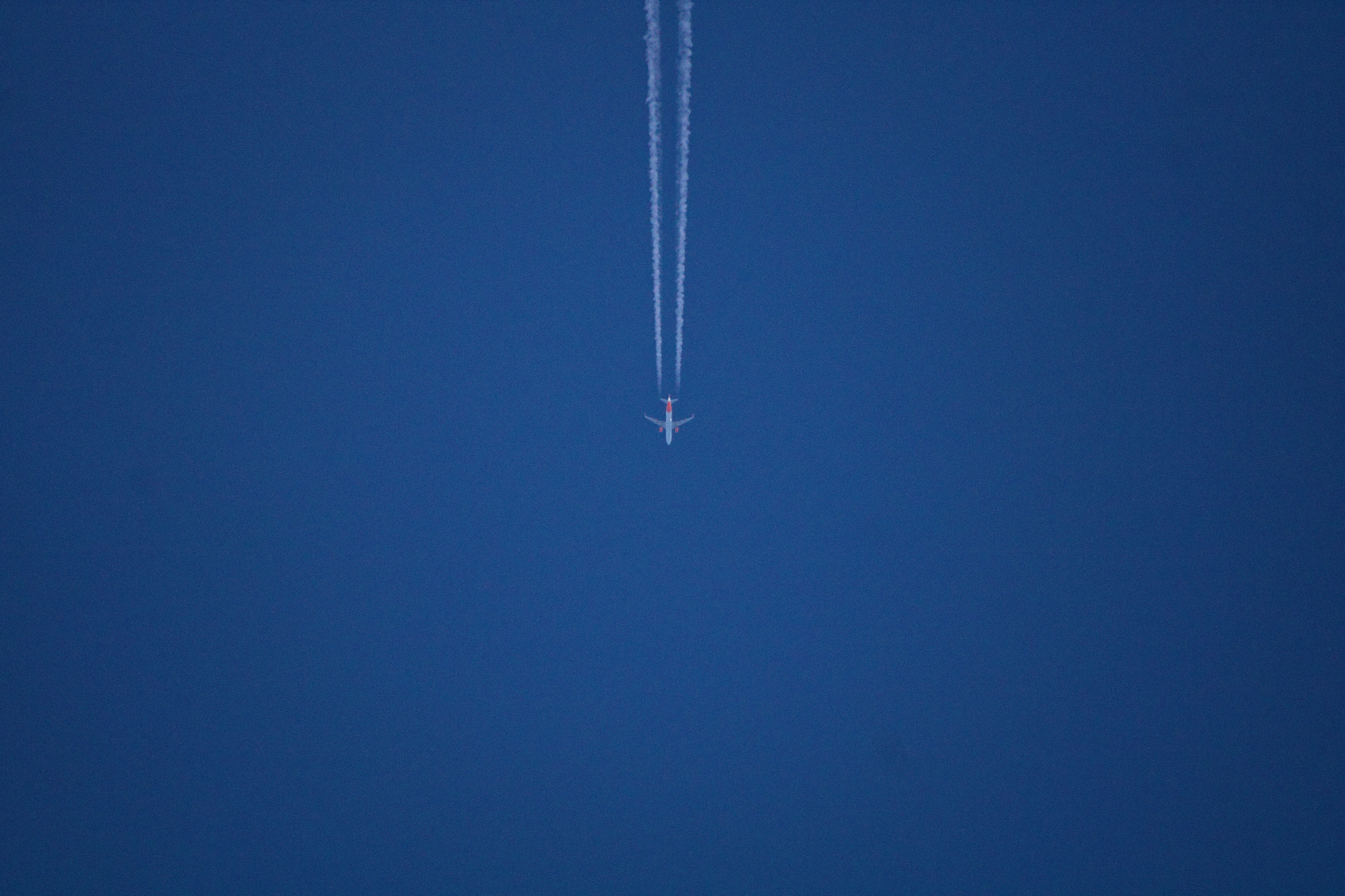 Jetliner Ascendant: Contrails Framing a Clear Sky