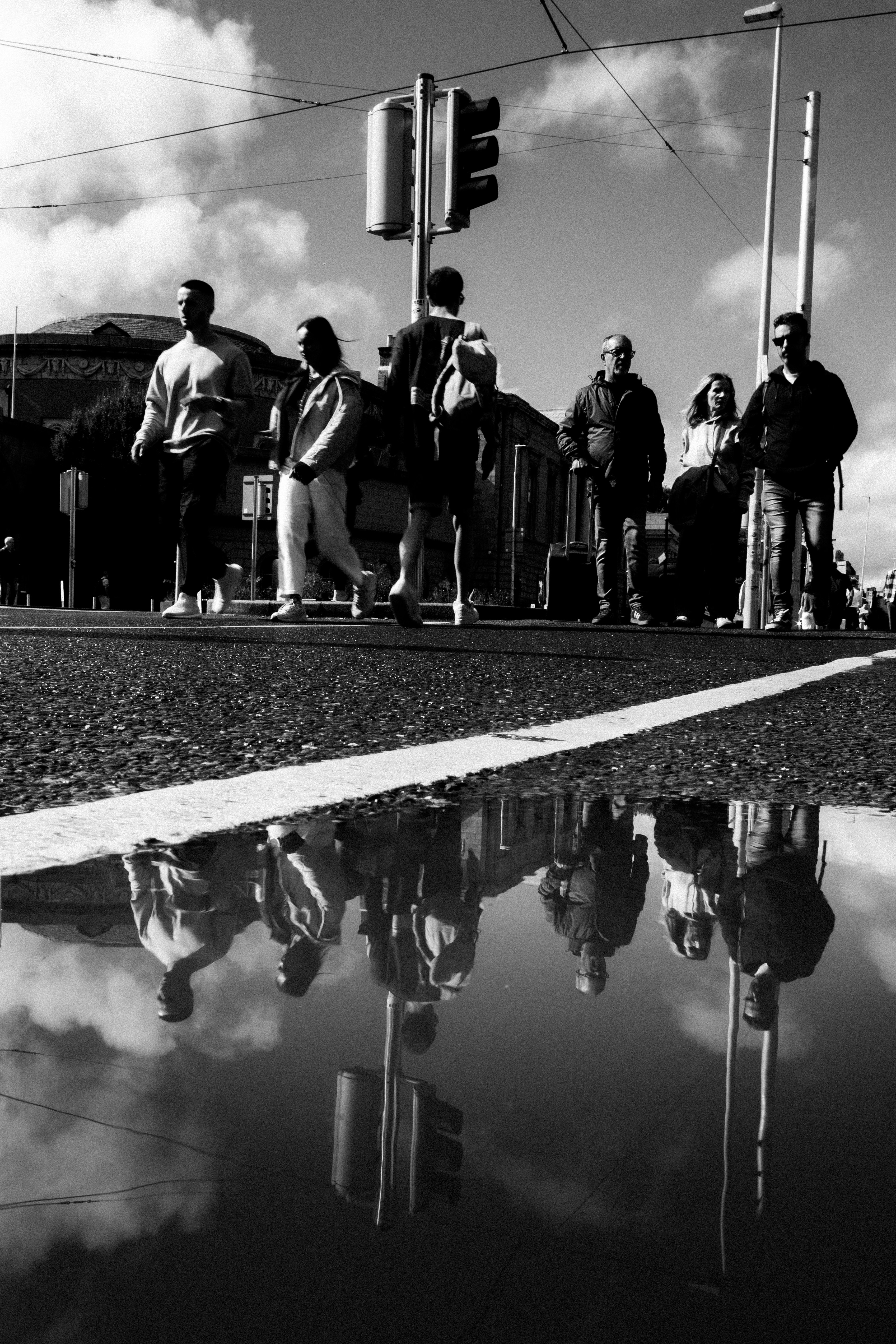 Crosswalk Shadows: A Black-and-White Moment of City Walkers