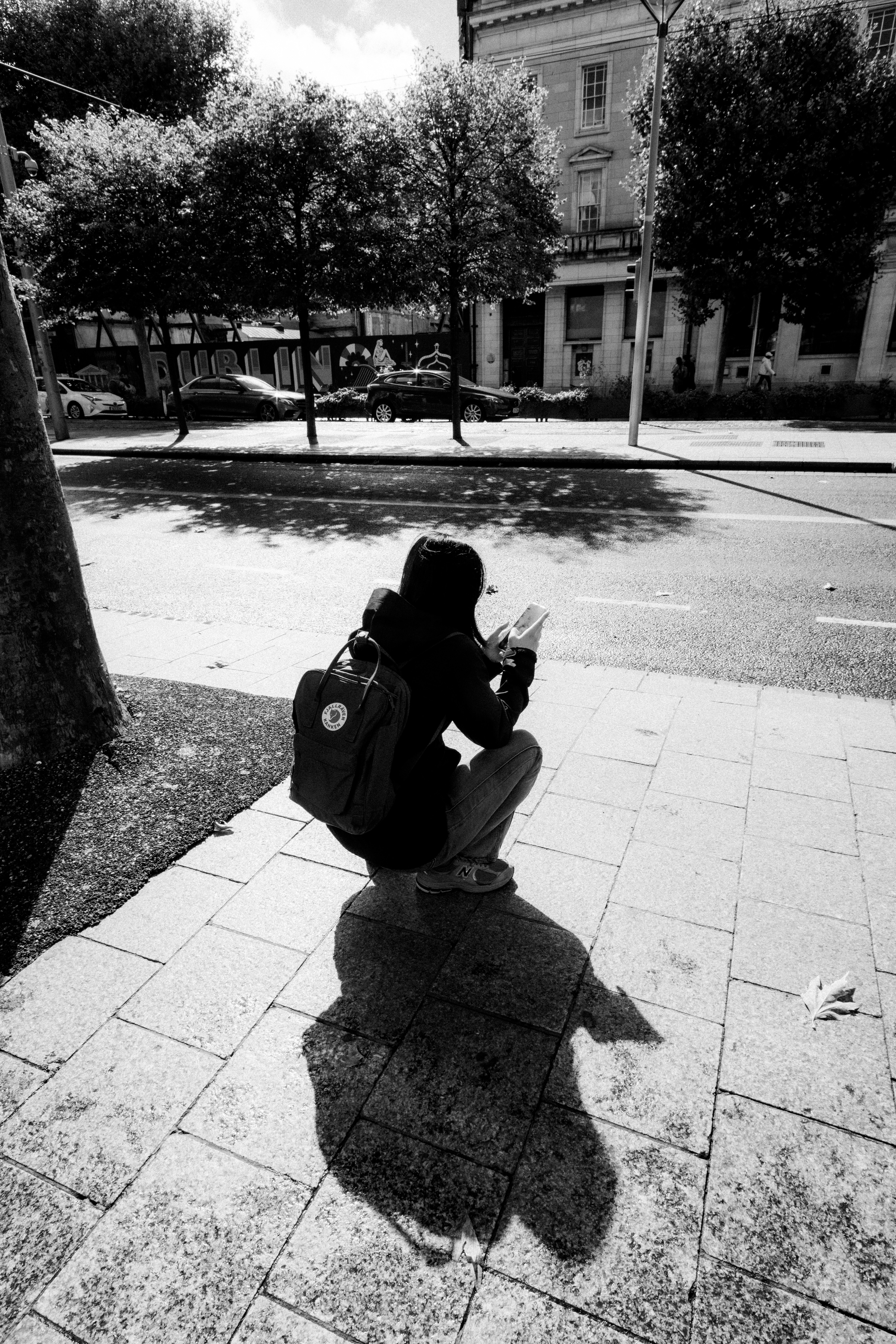 Crouched Reader in a Sunlit City