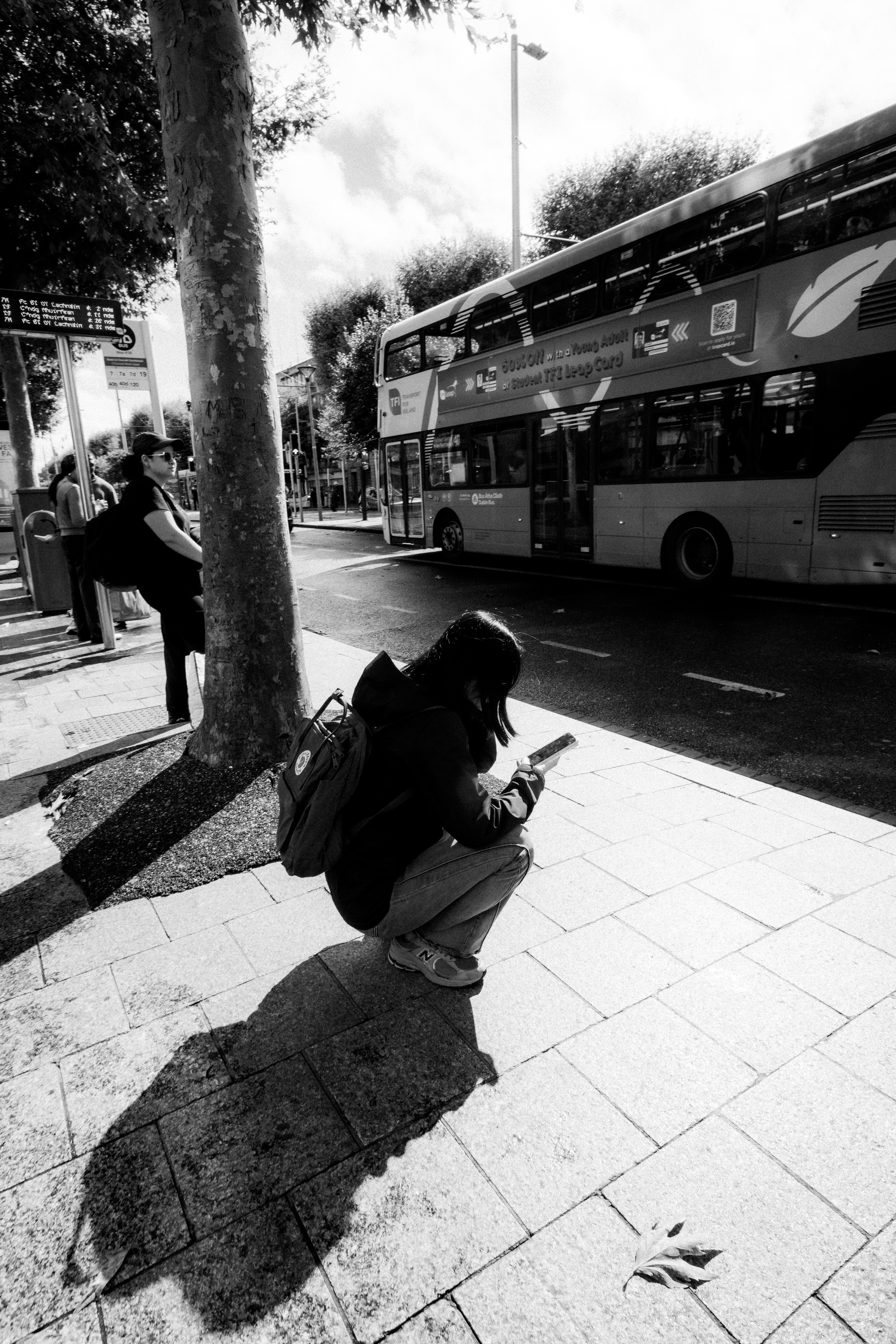 Knee-Deep in Focus: A Quiet Moment on the Bus Stop