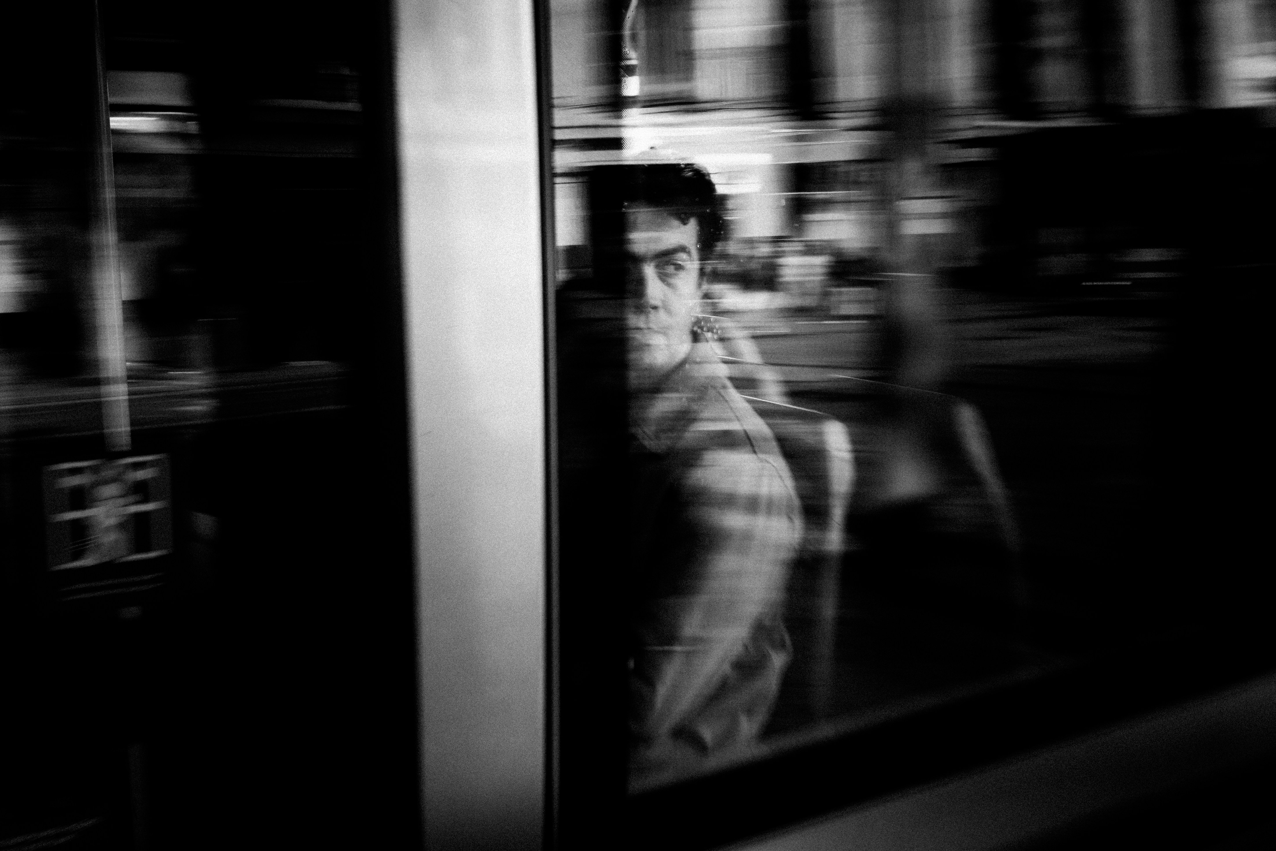 Passing Glance: A Truncated Moment Through Reflected Glass