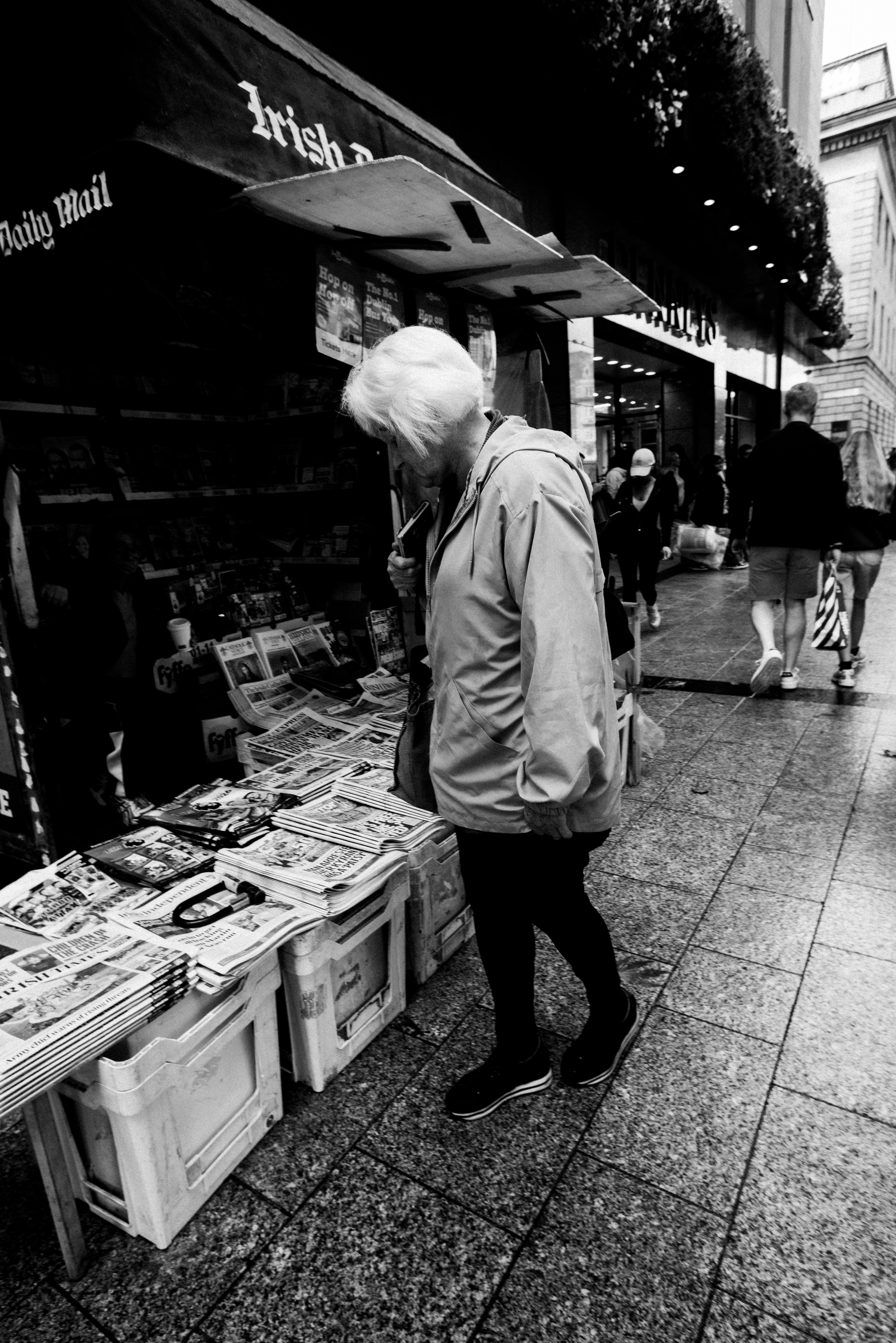 Street Vendor and Curious Shopper in a Black-and-White City Scene