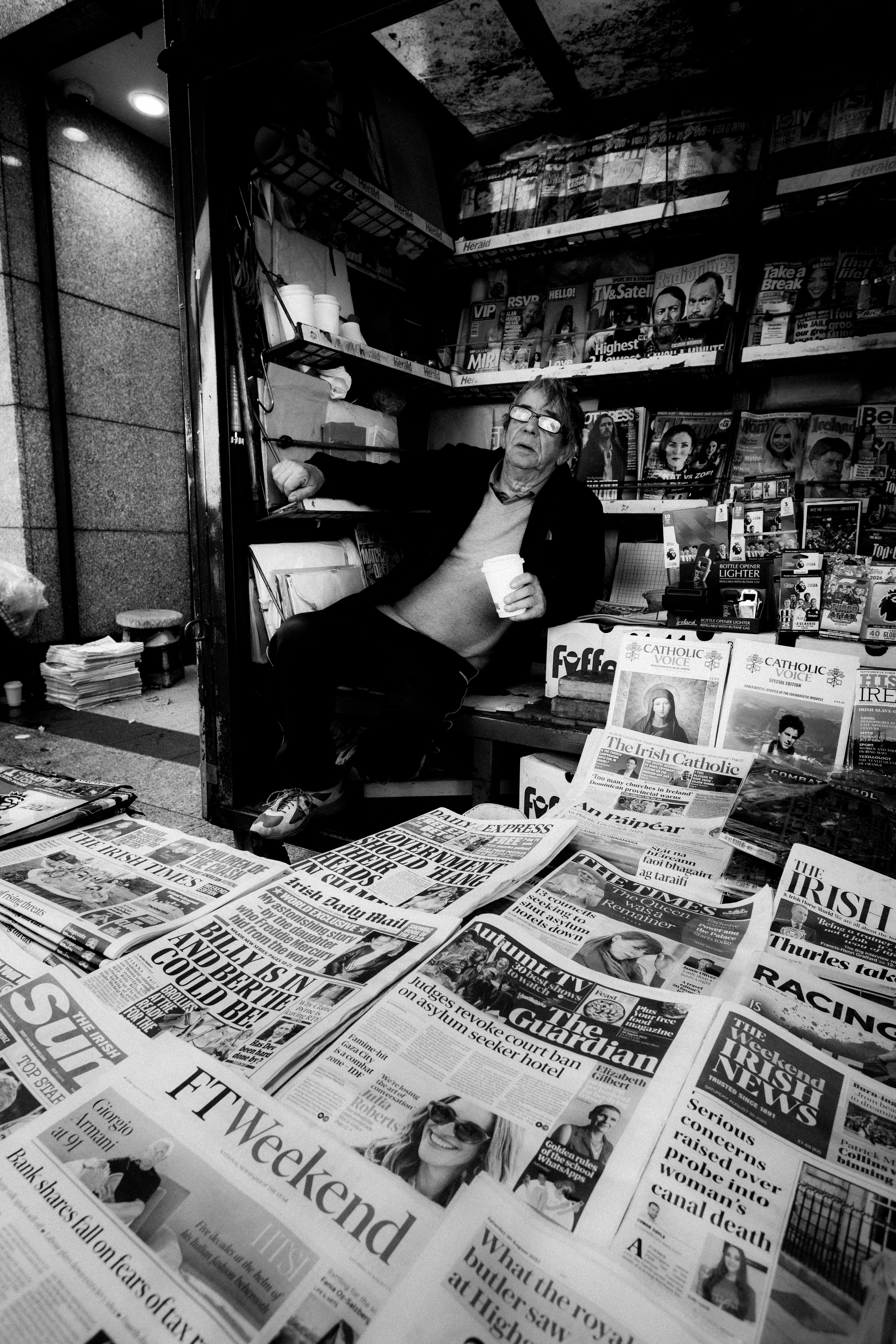 Newspaper Corner: A Street Editor Reclines Among Headlines